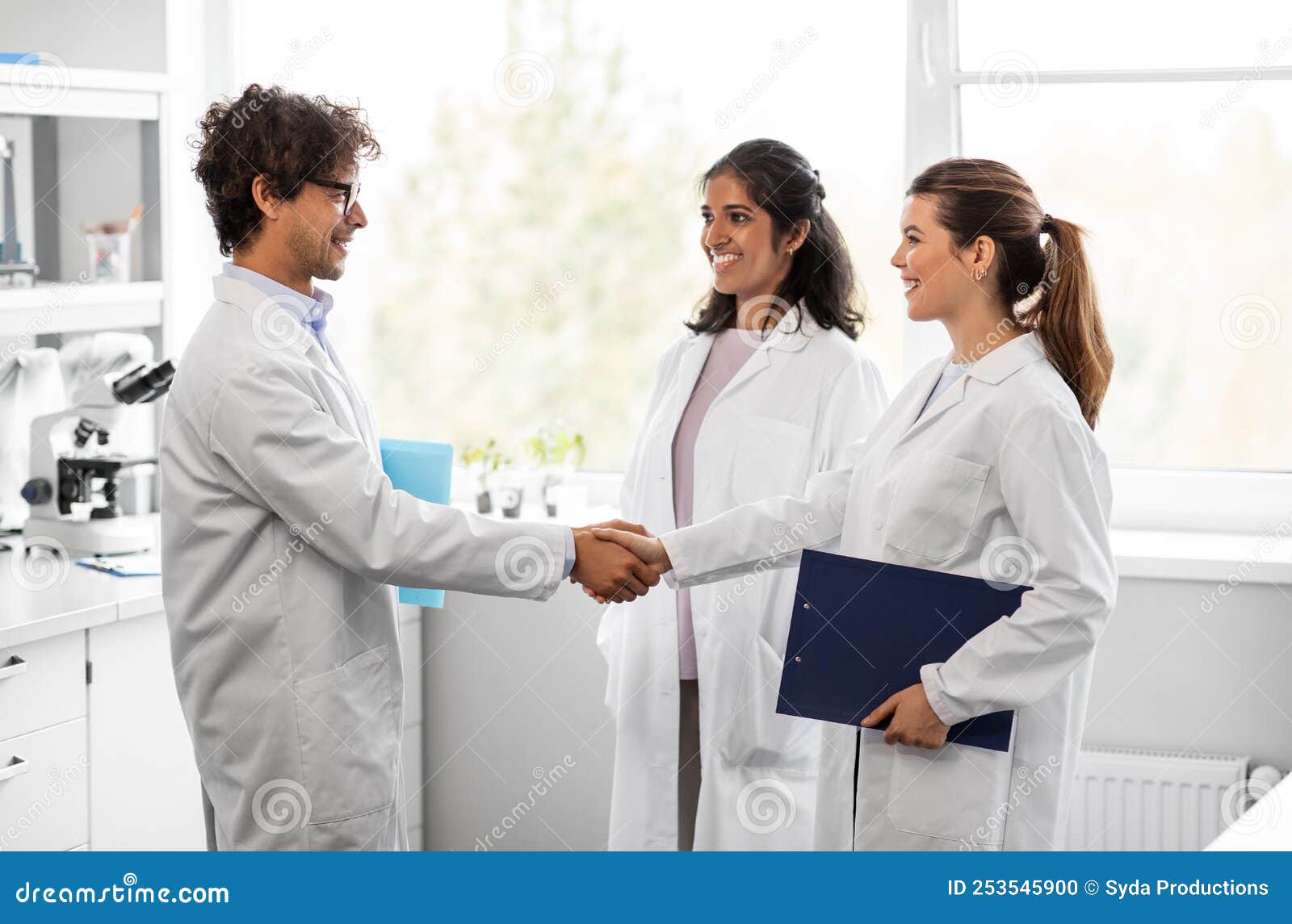 Scientists Shaking Hands in Laboratory Stock Photo - Image of science ...