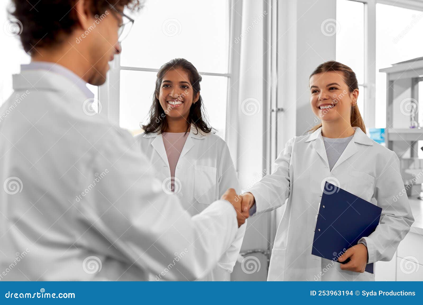 Scientists Shaking Hands in Laboratory Stock Photo - Image of group ...
