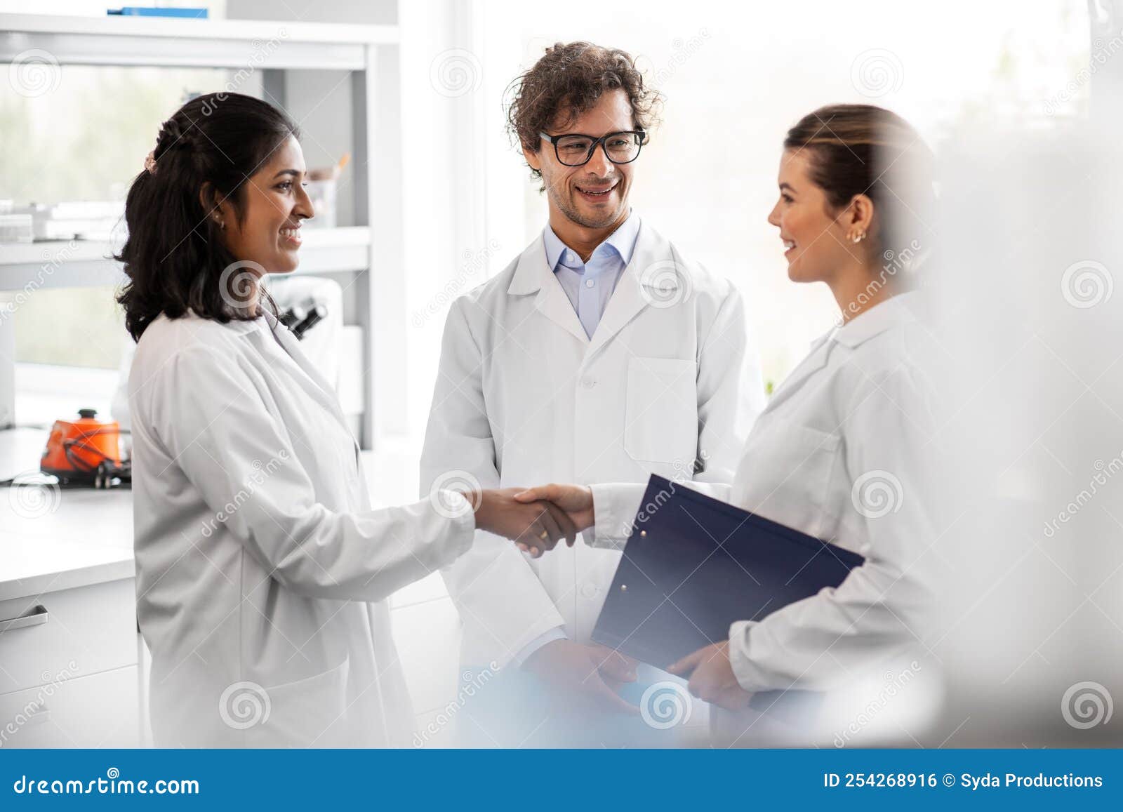Scientists Shaking Hands in Laboratory Stock Photo - Image of people ...