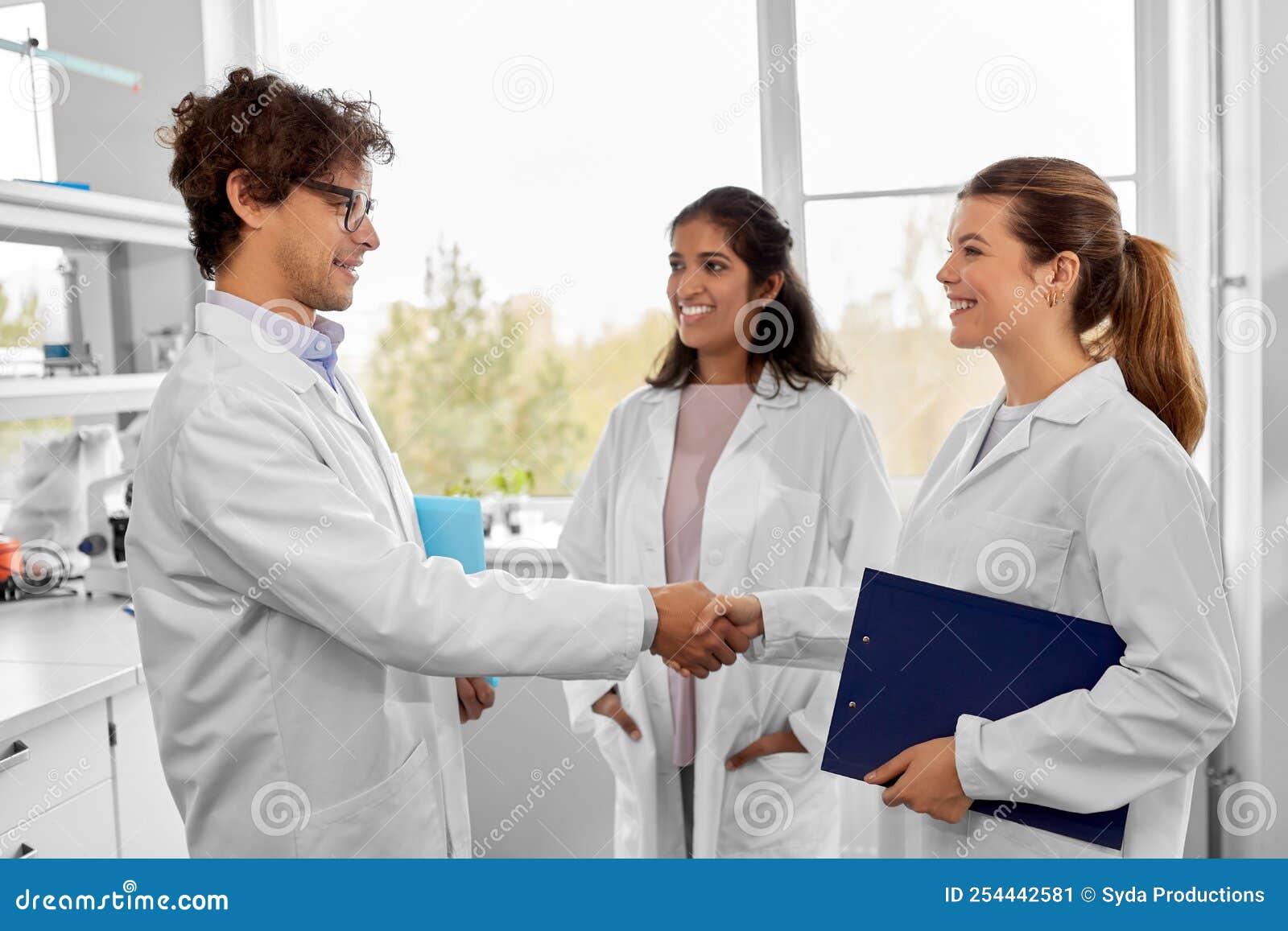 Scientists Shaking Hands in Laboratory Stock Image - Image of biology ...