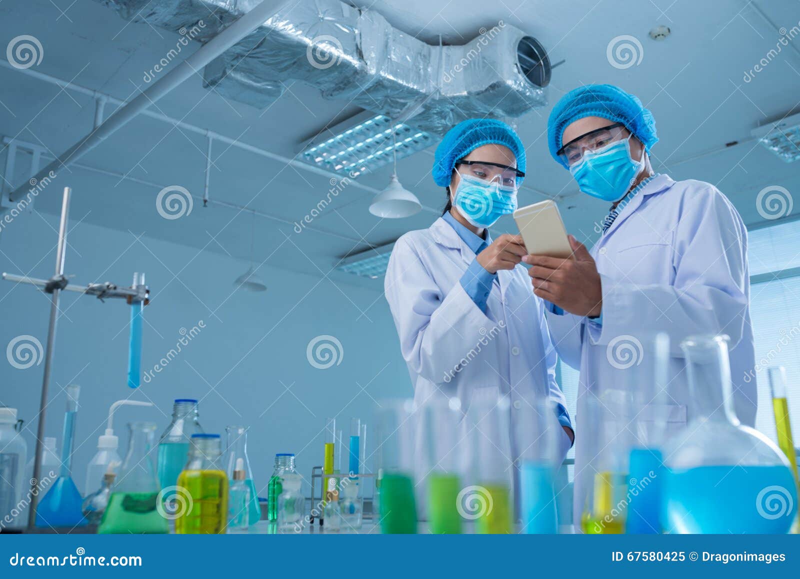 Scientists with smartphone stock image. Image of researcher - 67580425