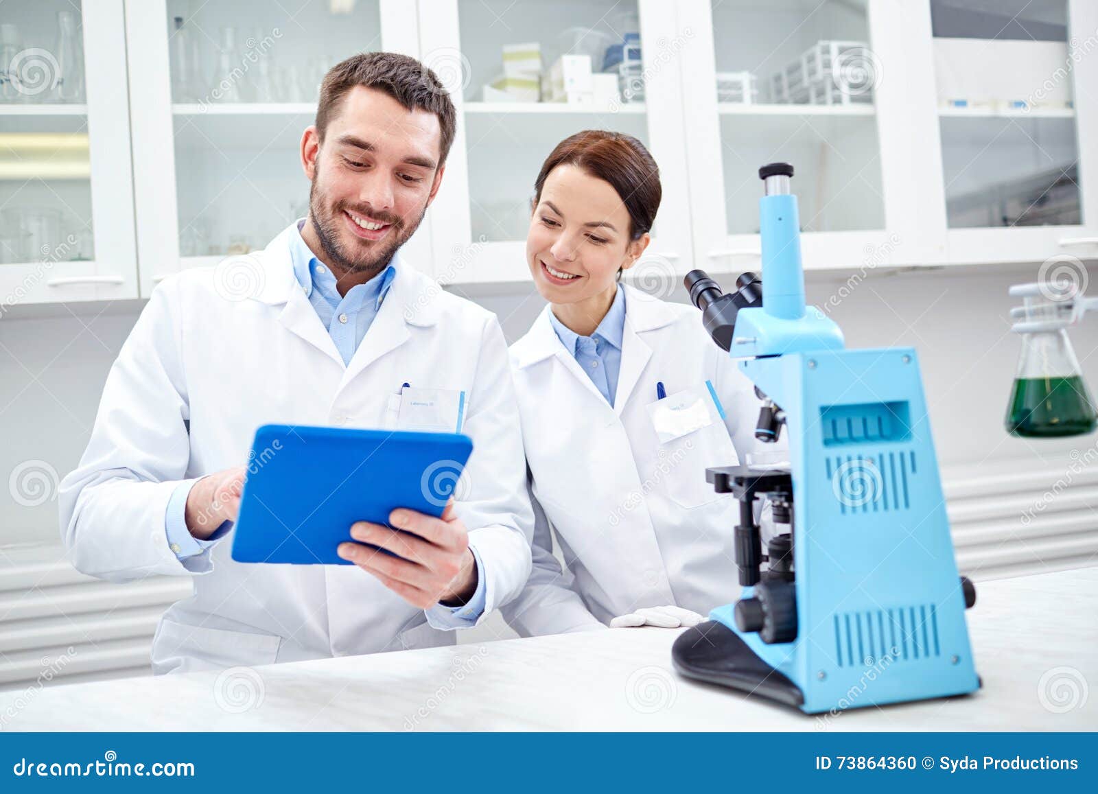Scientists with Tablet Pc and Microscope in Lab Stock Photo - Image of ...