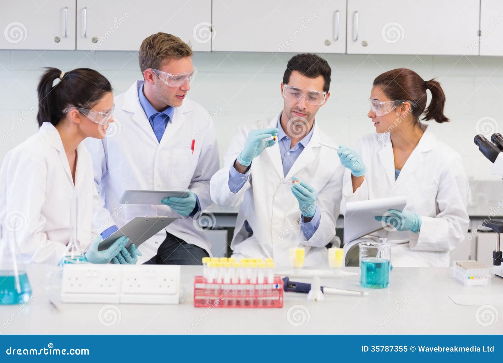 Scientists with Tablet PC Working on Experiment at Lab Stock Image ...