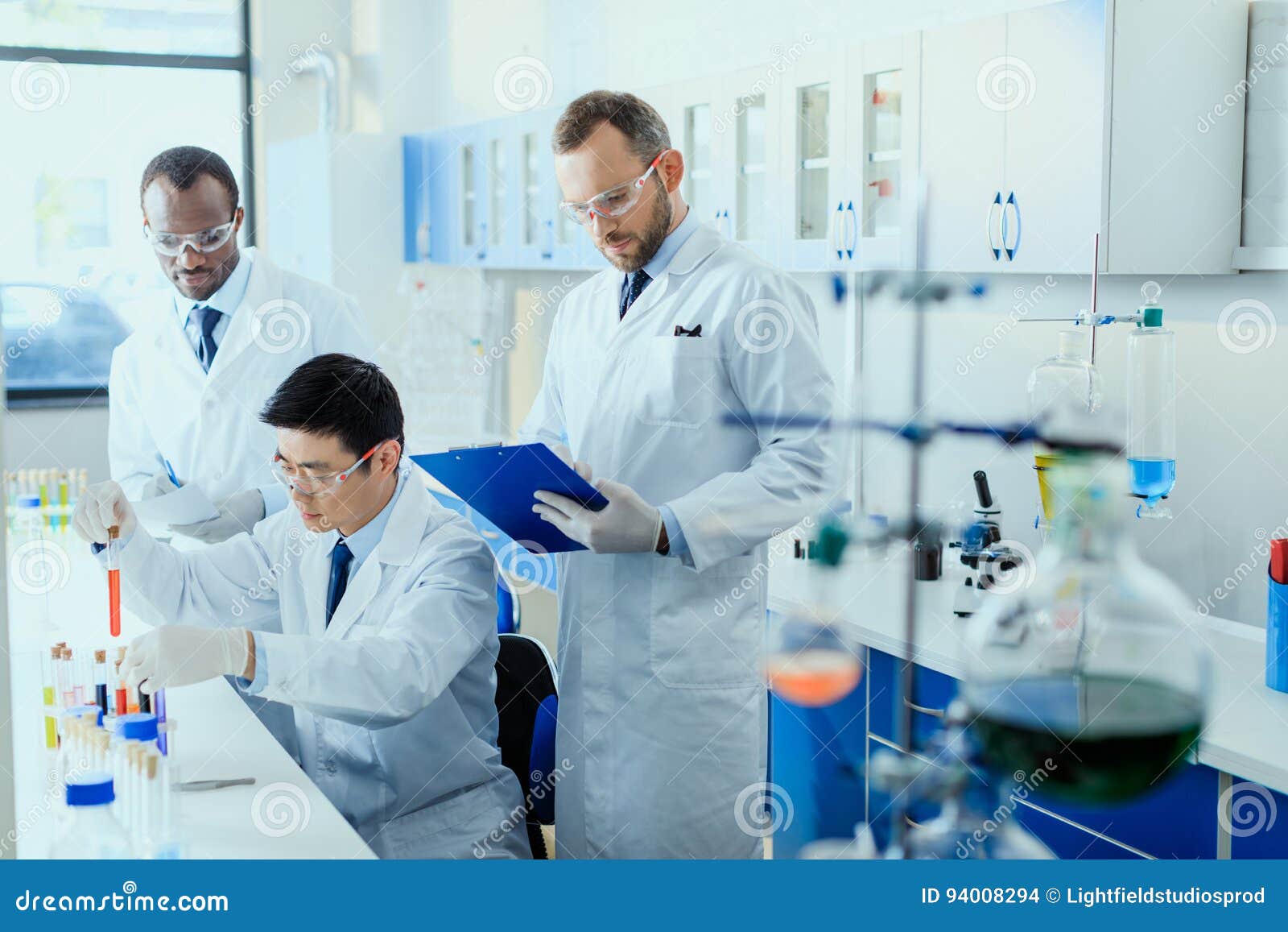 Scientists in White Coats Working Together in Chemical Laboratory Stock ...