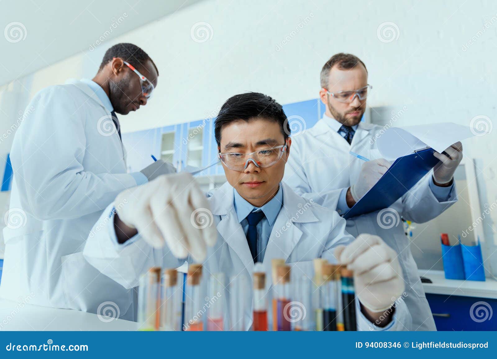 Scientists in White Coats Working Together in Chemical Laboratory Stock ...