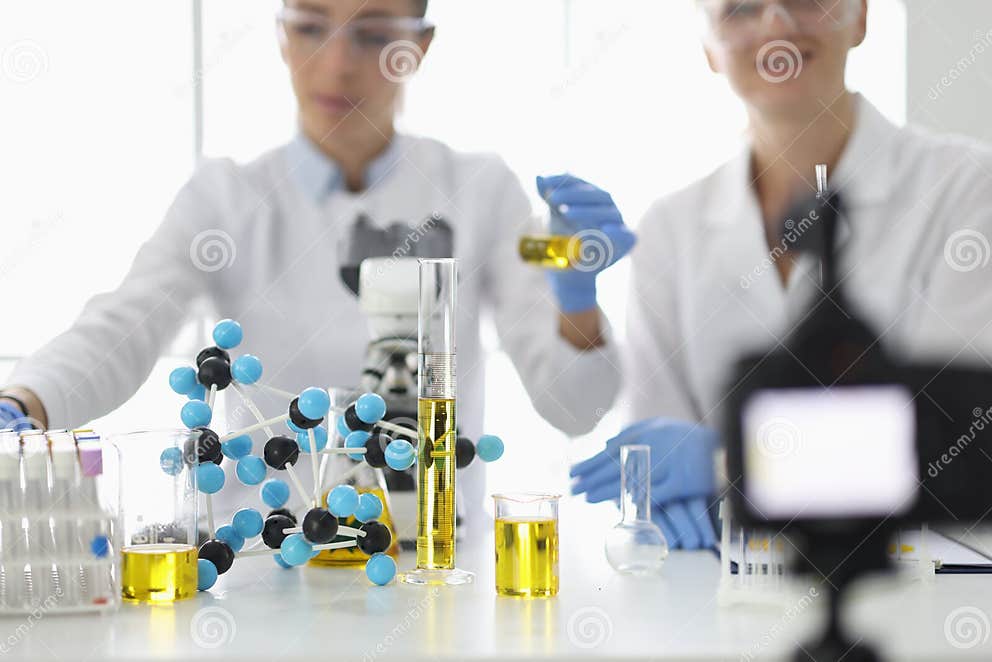 Scientists at Work Table on Which Flasks and Molecules are Filming ...