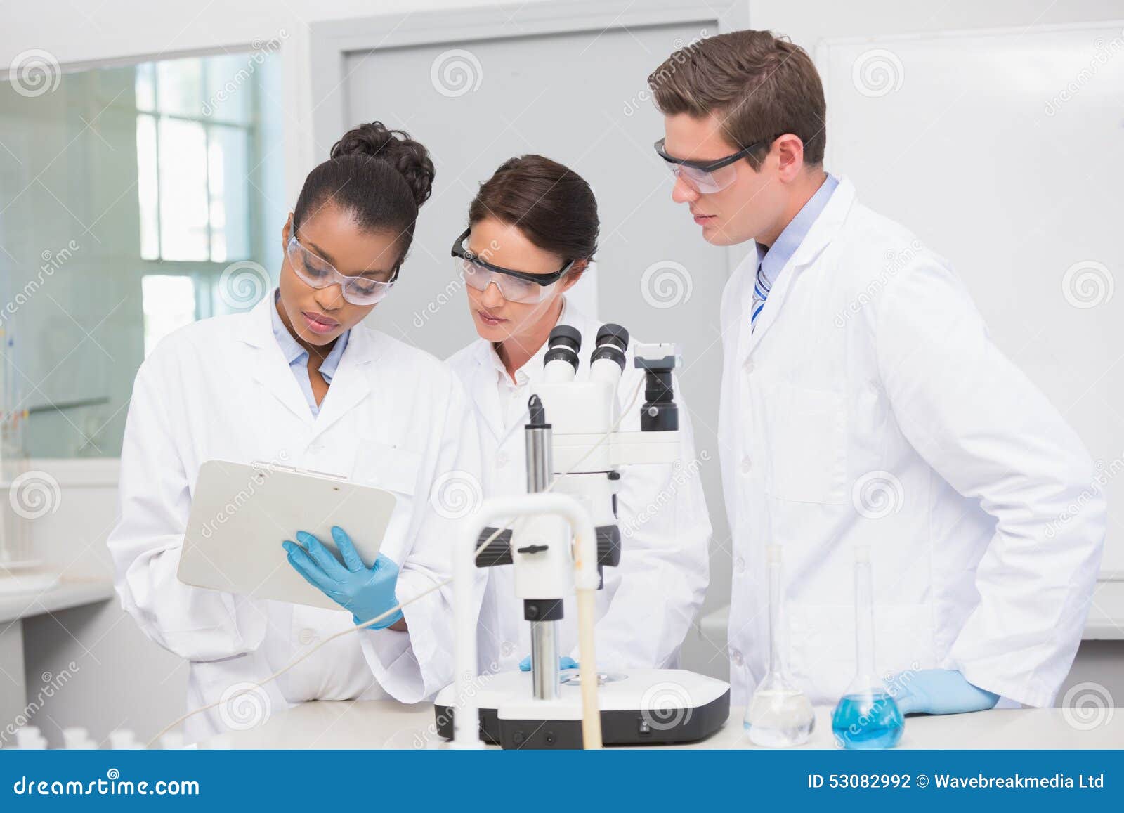 Scientists Working with Microscope and Taking Notes Stock Photo - Image ...