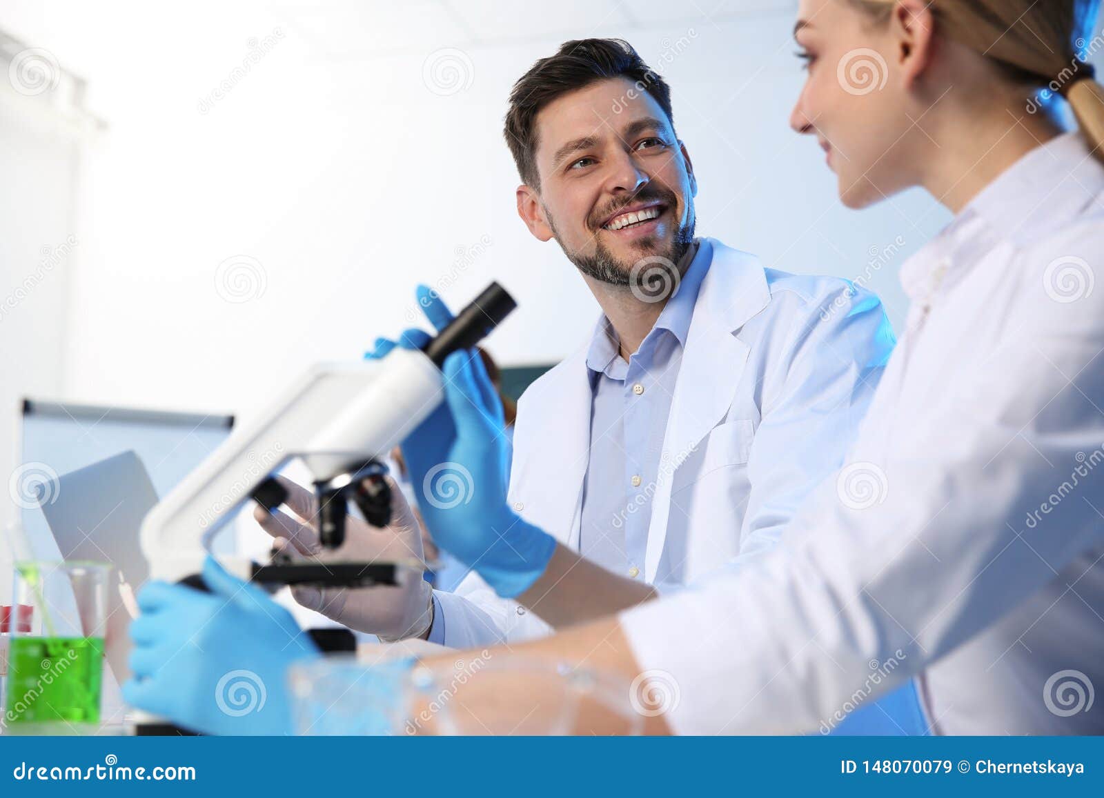 Scientists Working at Table in Chemistry Laboratory Stock Image - Image ...