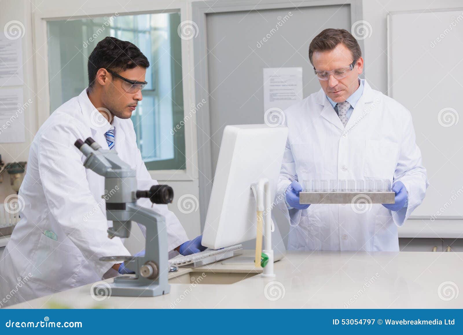 Scientists Working Together on Tubes and Computer Stock Image - Image ...