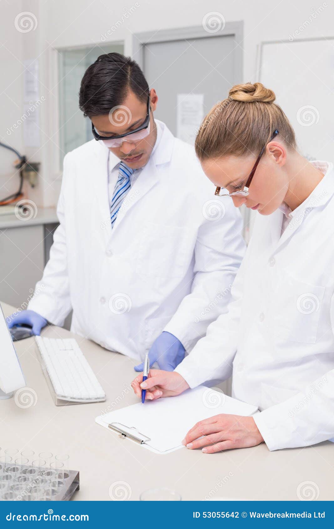 Scientists Writing on Clipboard Stock Photo - Image of concentrated ...