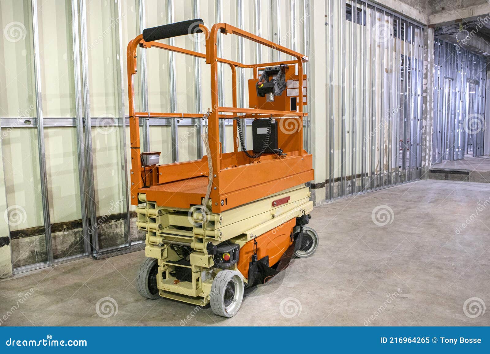Builder On A Scissor Lift Platform At A Construction Site Stock Image ...