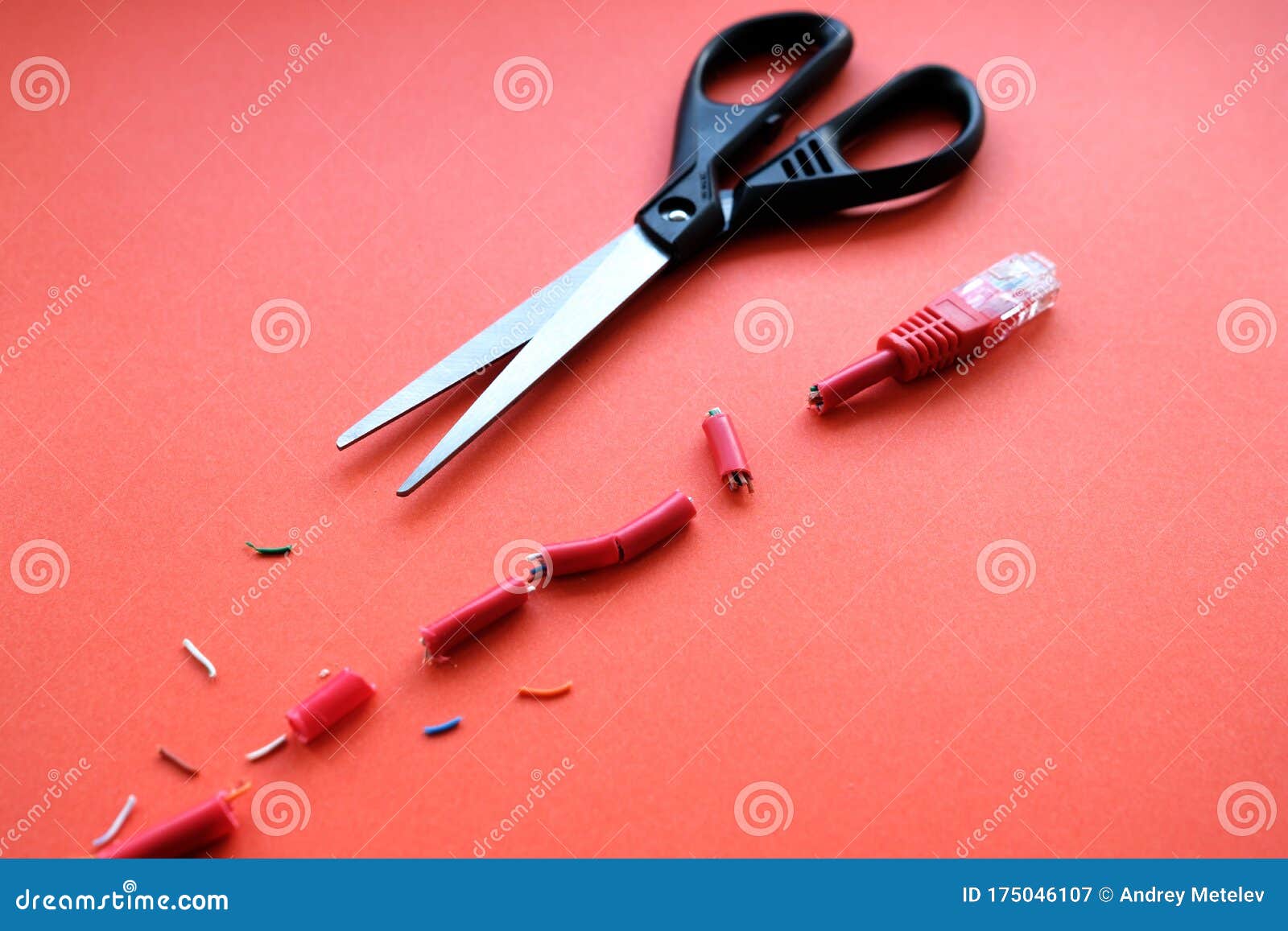 Scissors and Cable Cut into Small Pieces on a Red Background Stock ...