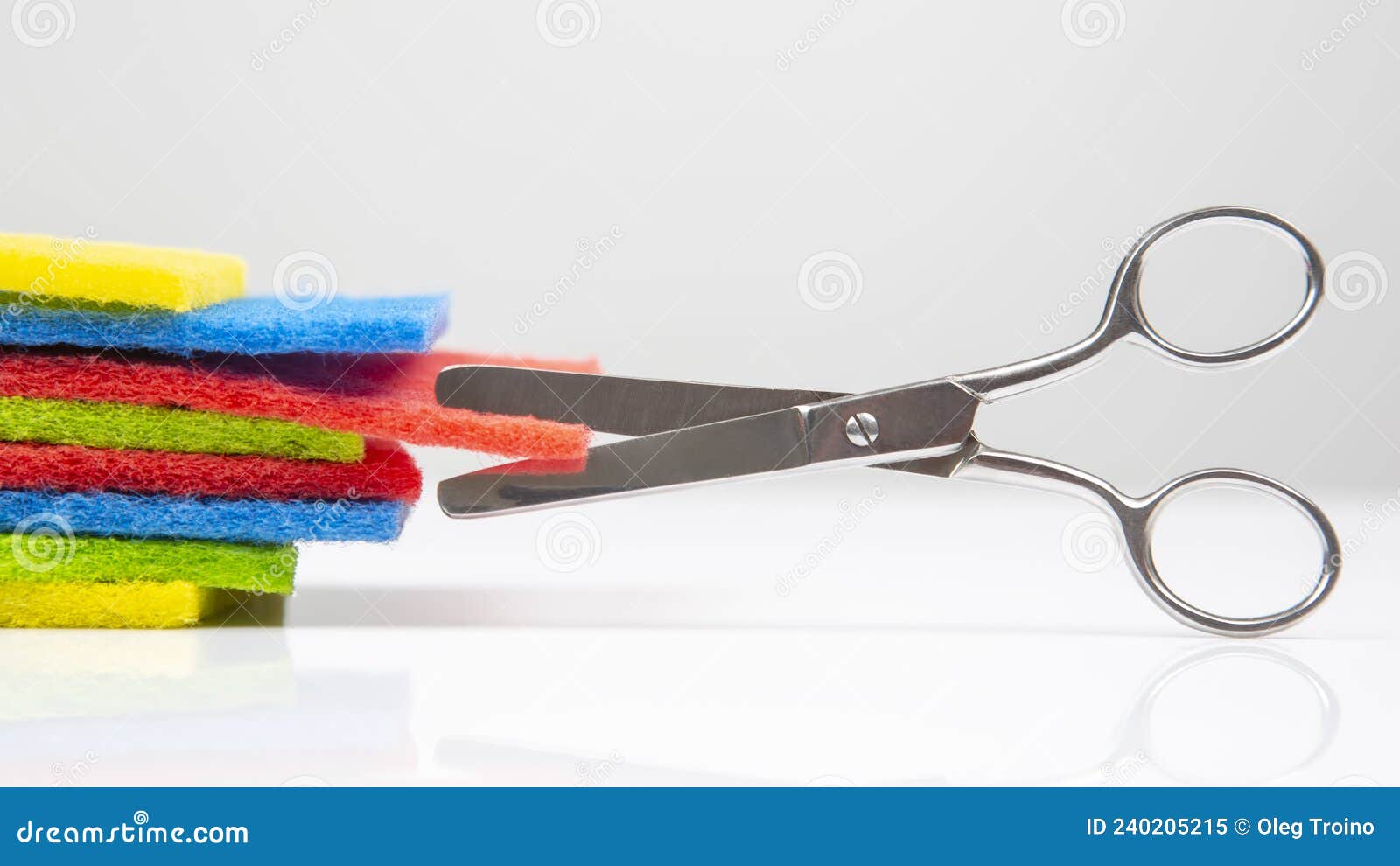 Scissors Cut Out a Sample of Colored Material on a White Background ...