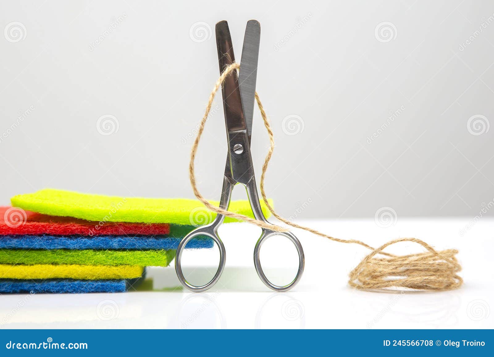 Scissors Cut Out a Sample of Colored Material on a White Background ...