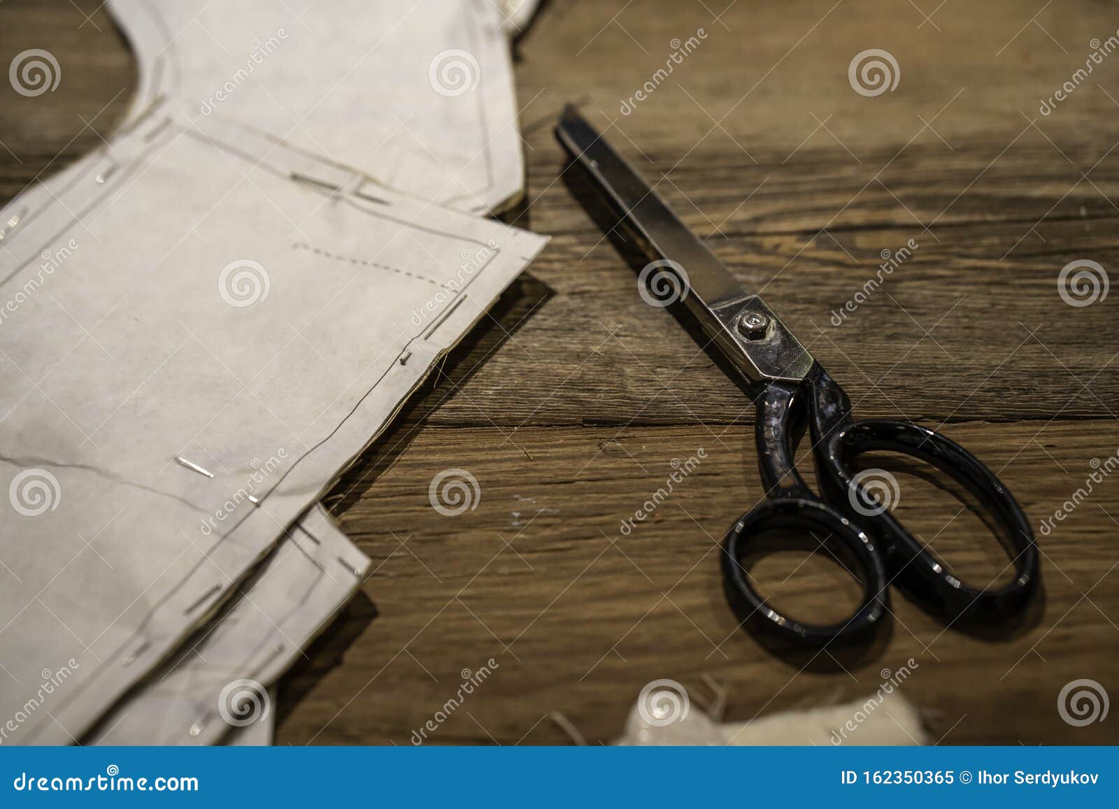 Scissors, Cutting Paper Pattern with Light Beige Fabric. Close-up ...