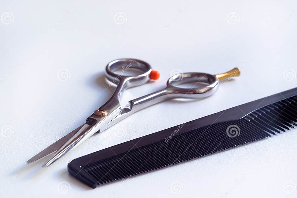 Scissors with Finger Rest on Ring and Comb Isolated on White Background ...
