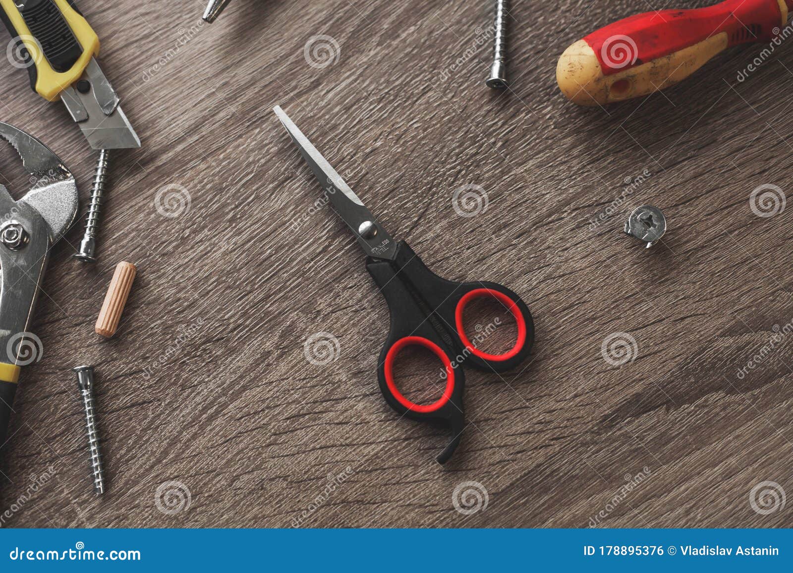 Scissors Lying on a Wooden Table among a Pile of Tools Stock Photo ...