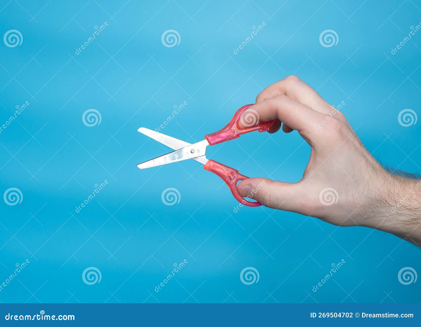 Scissors in a Man S Hand on a Blue Background, a Barber Man with ...