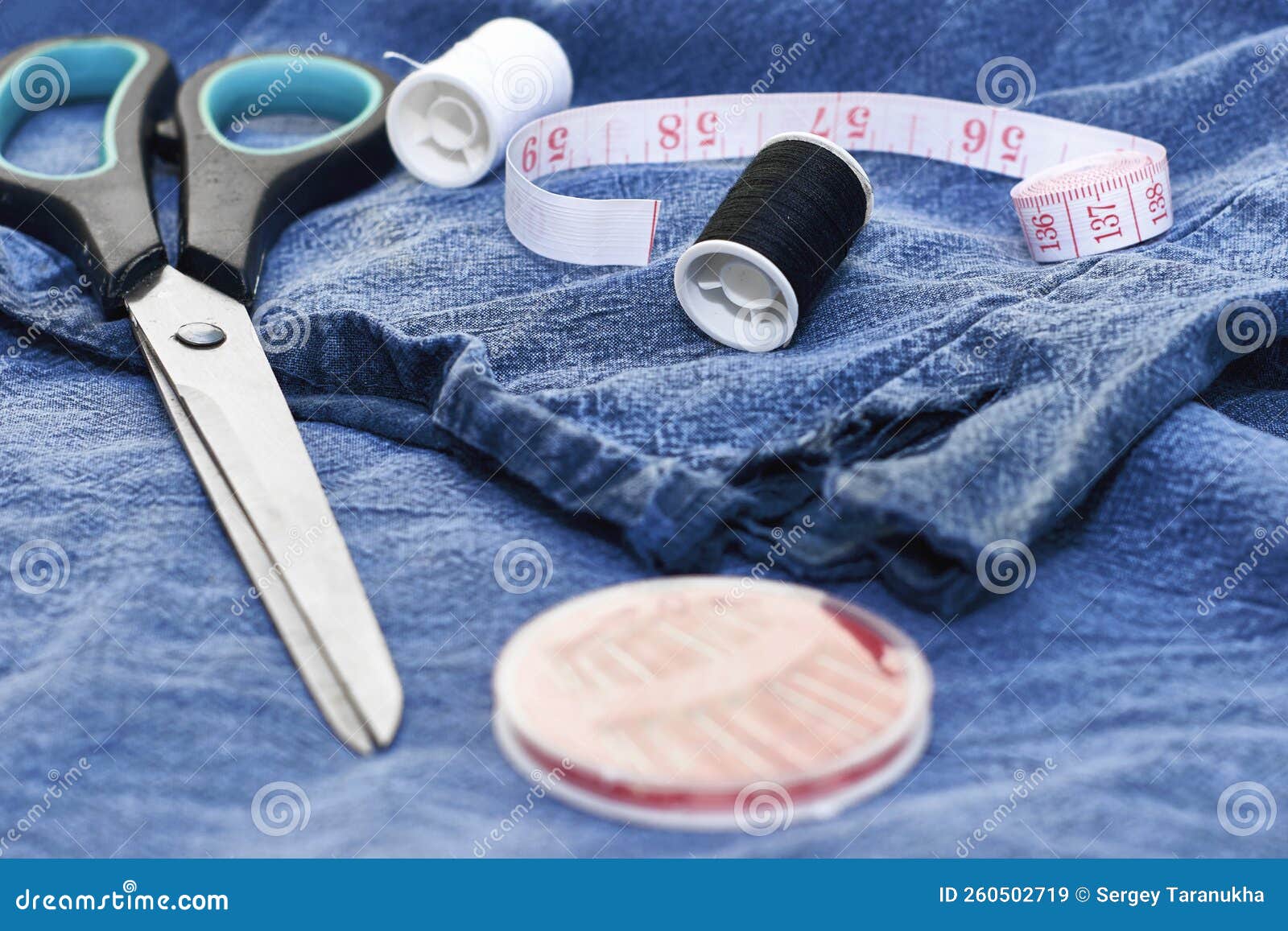 Scissors Needles Measuring Tape and Thread on the Background of Torn ...