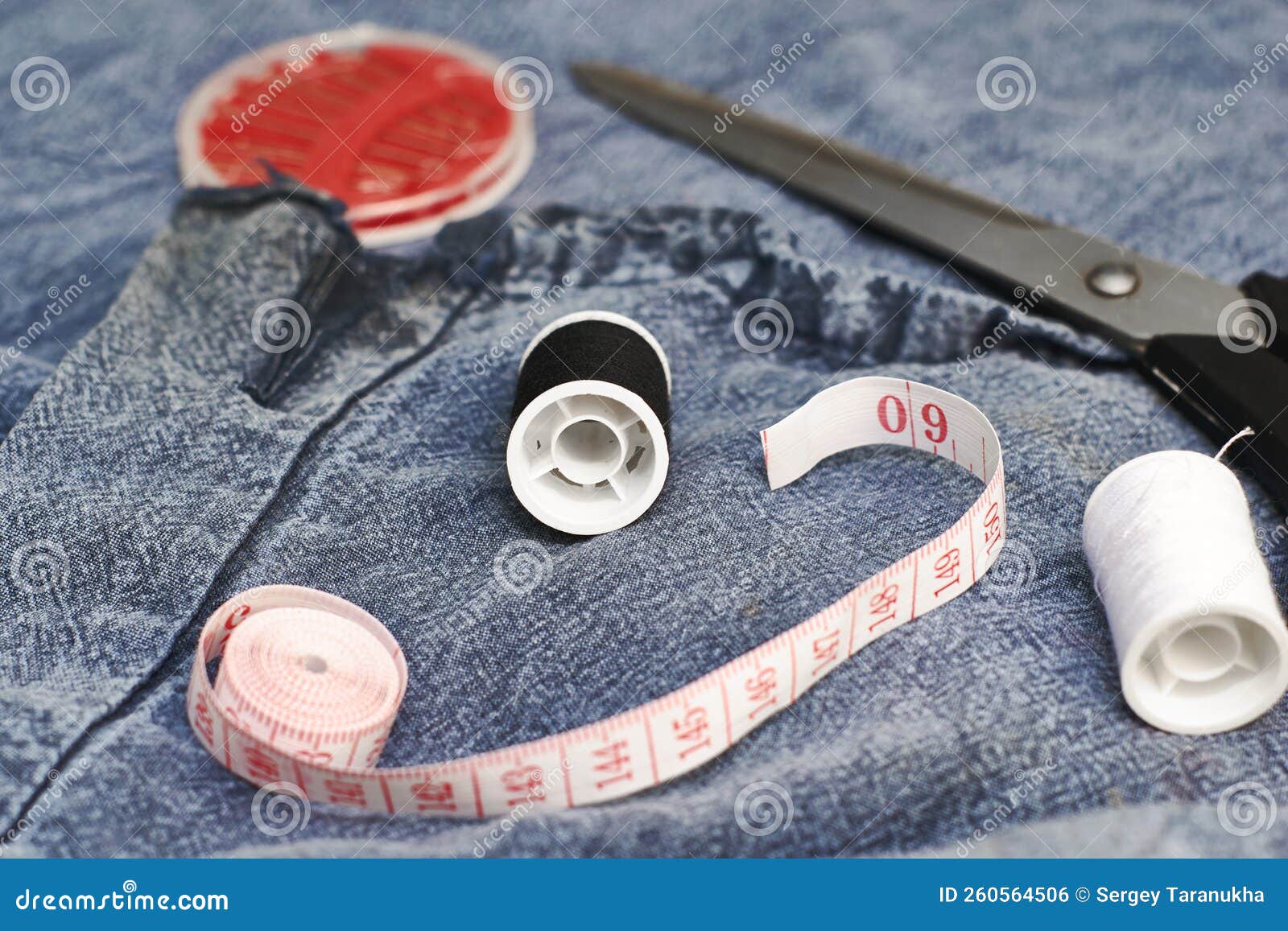 Scissors Needles Measuring Tape and Thread on the Background of Torn ...