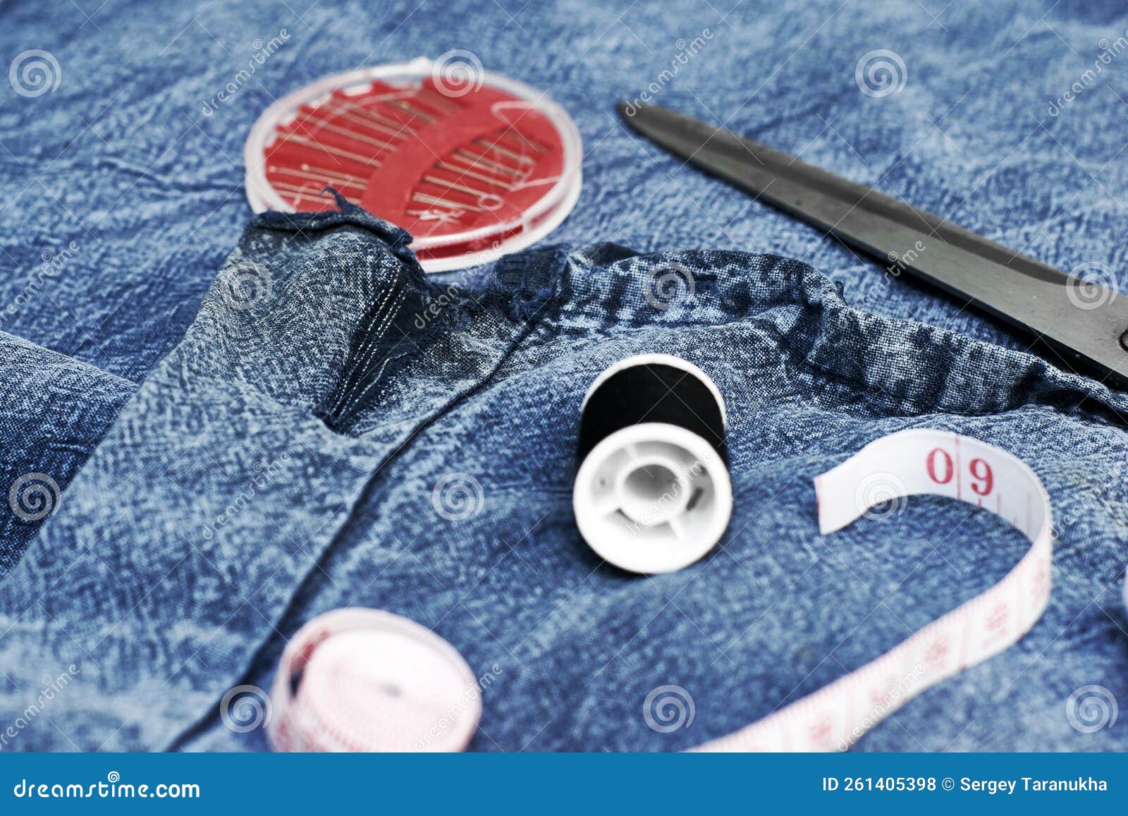 Scissors Needles Measuring Tape and Thread on the Background of Torn ...