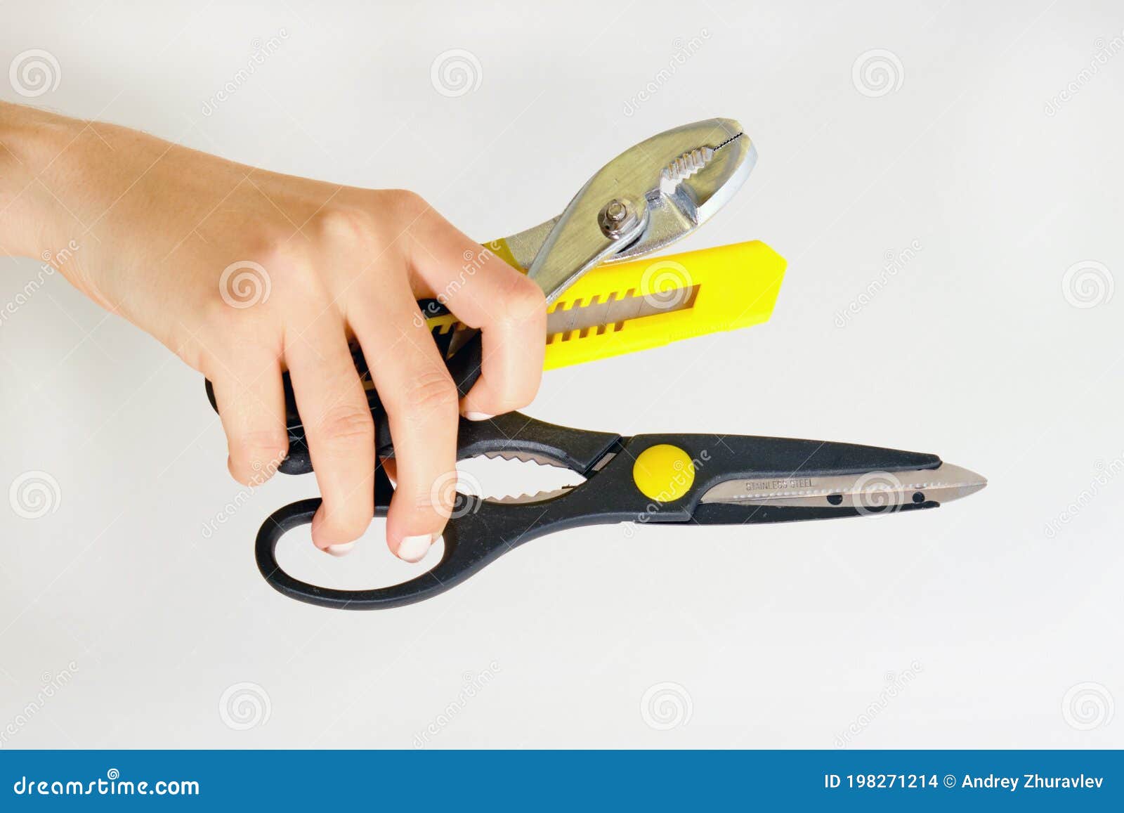 Scissors, Pliers And A Knife For Cutting Paper In Hand. Construction ...