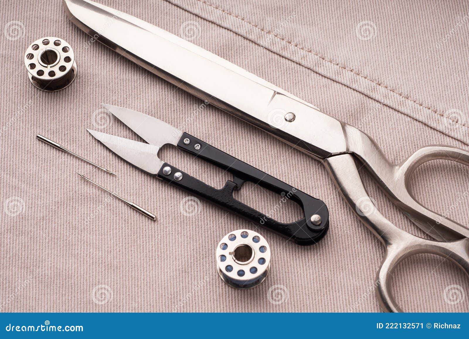 Scissors, Spools of Thread, Needles, and a Centimeter Lie on the Dark ...