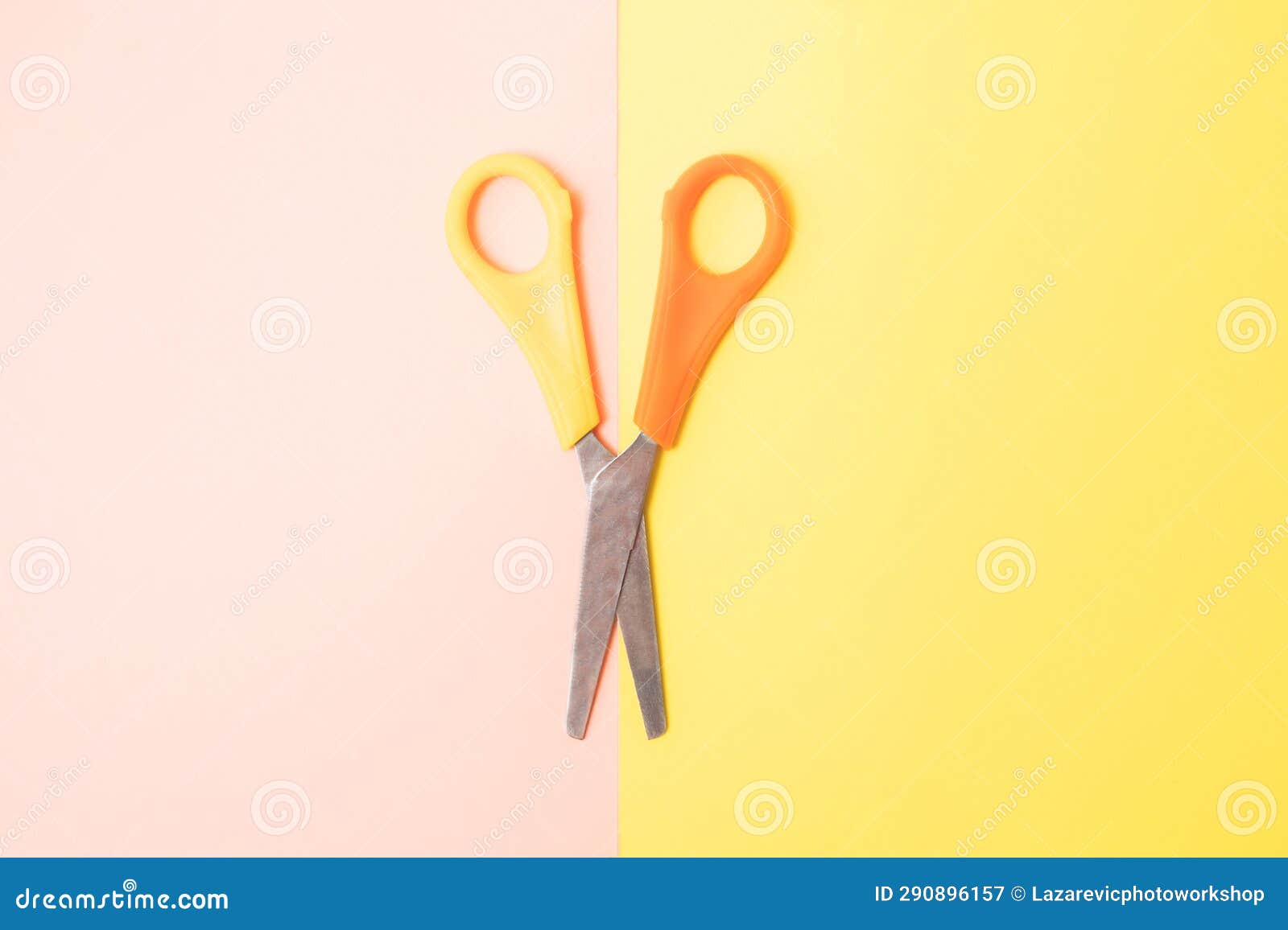 Scissors with Yellow and Orange Handle on Light Pastel Pink and Yellow ...