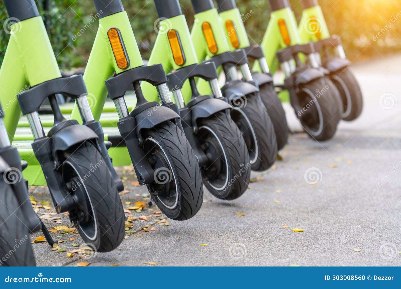 Scooters Lined Up in a Summer Parking Lot. Shows only the Front Wheels ...