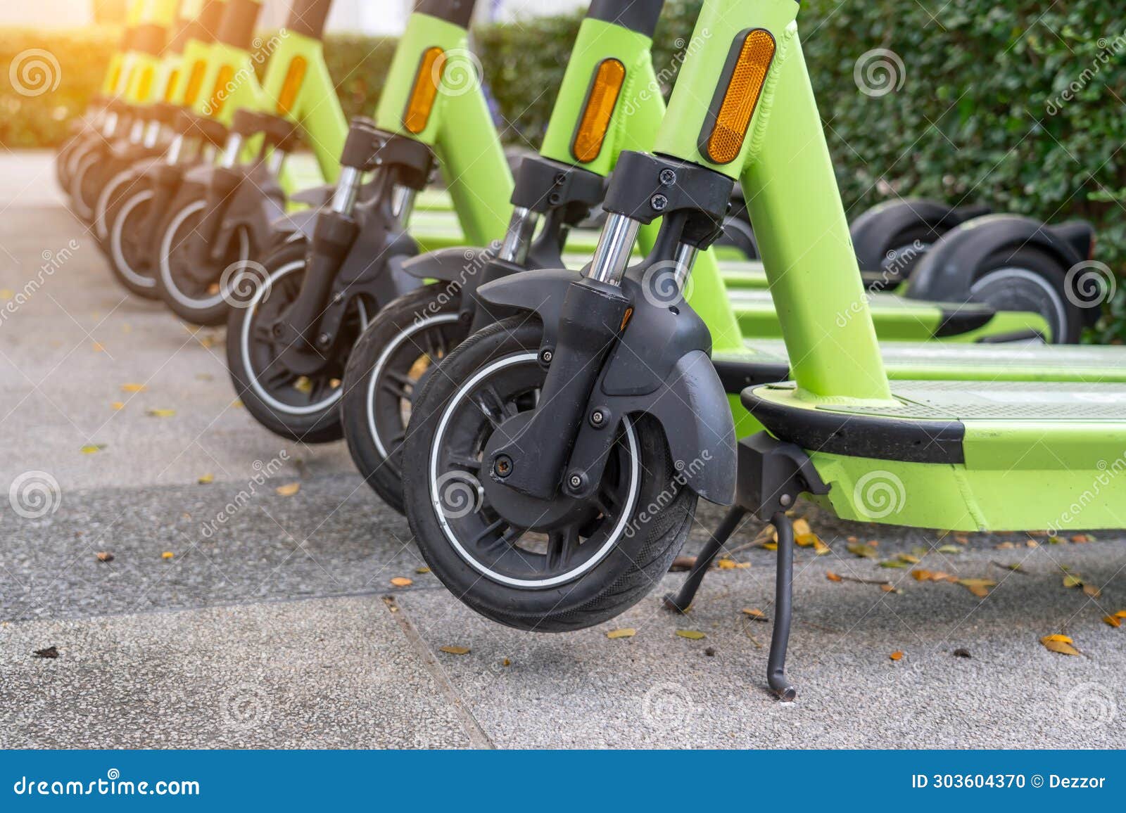 Scooters Lined Up in a Summer Parking Lot. Shows only the Front Wheels ...