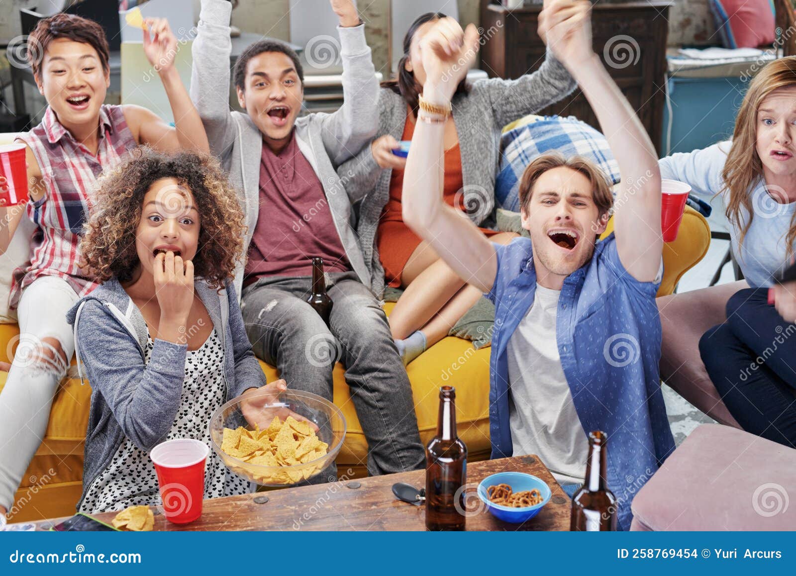 And we Scored. a Group of Friends Enjoying Snacks and Drinks while ...