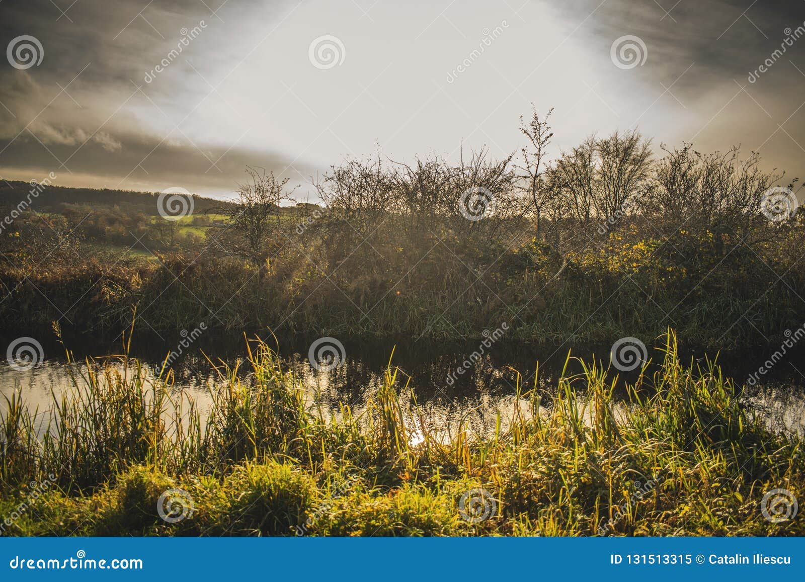 Scottish Dramatic Sky Landscape with River Grass and Powerful Sun Stock ...