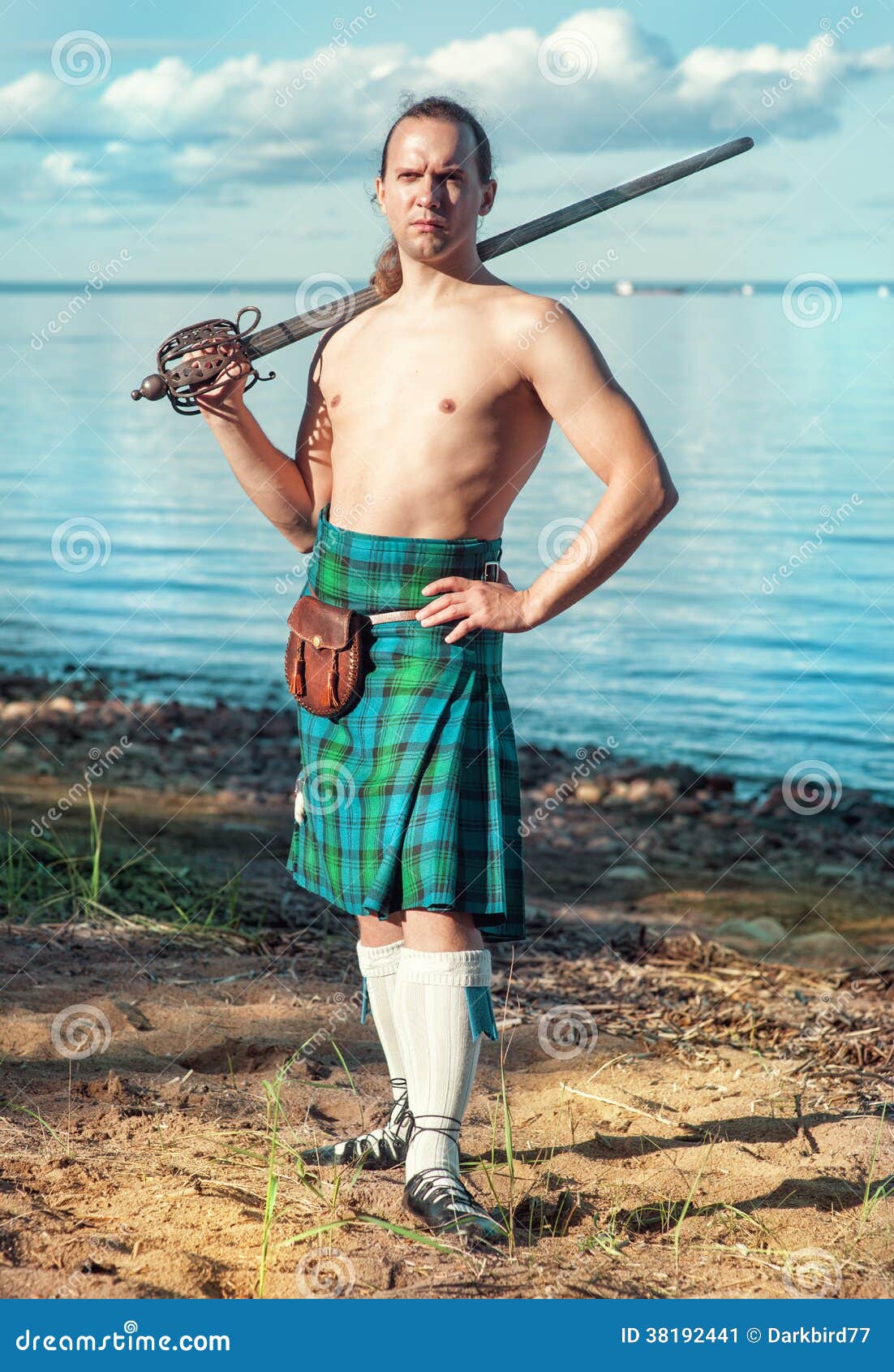 Scottish Man with Sword Near the Sea Stock Image - Image of plaid ...