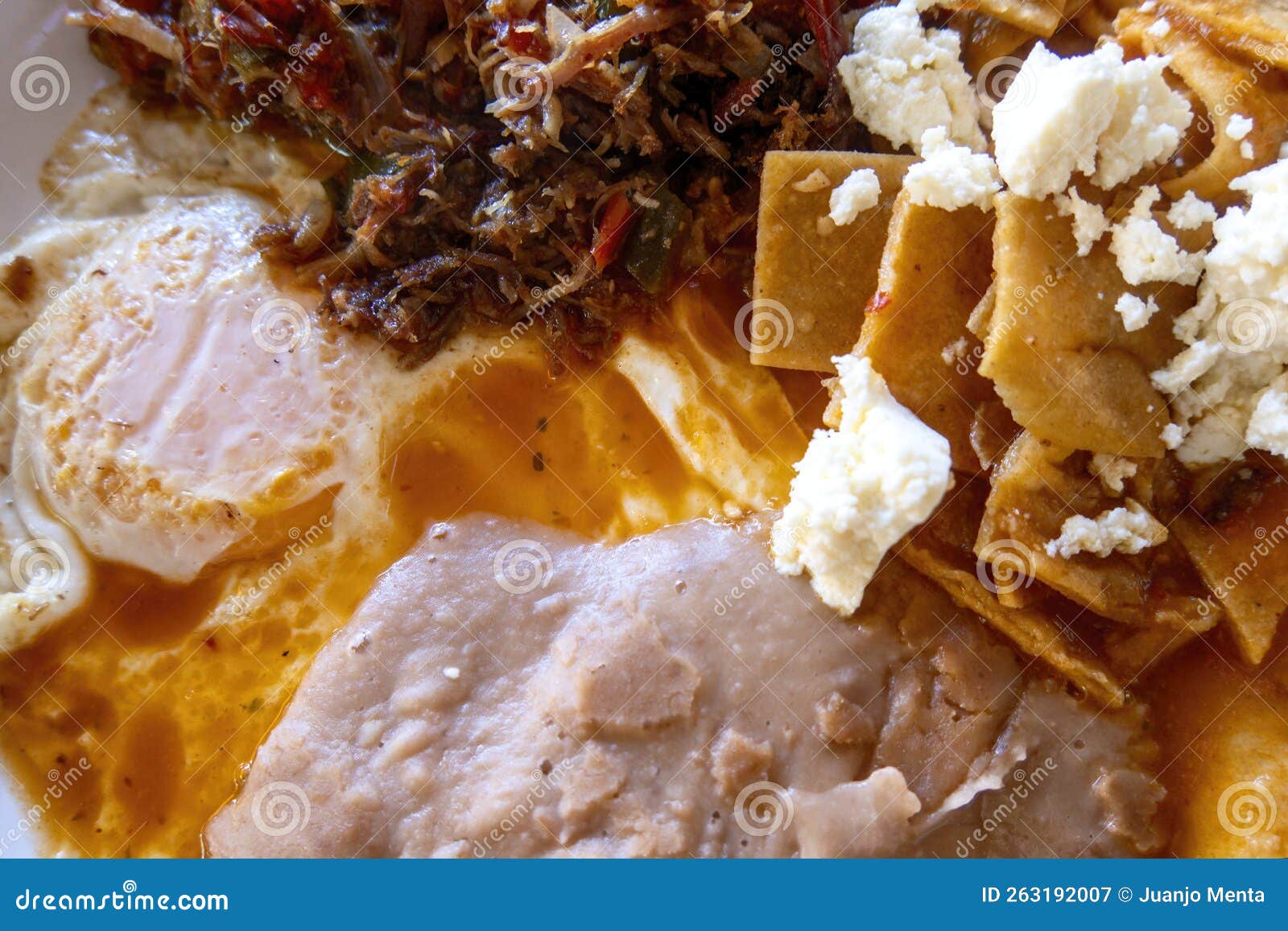 Scrambled Eggs with Machaca and Beans and Chilaquiles Stock Image ...