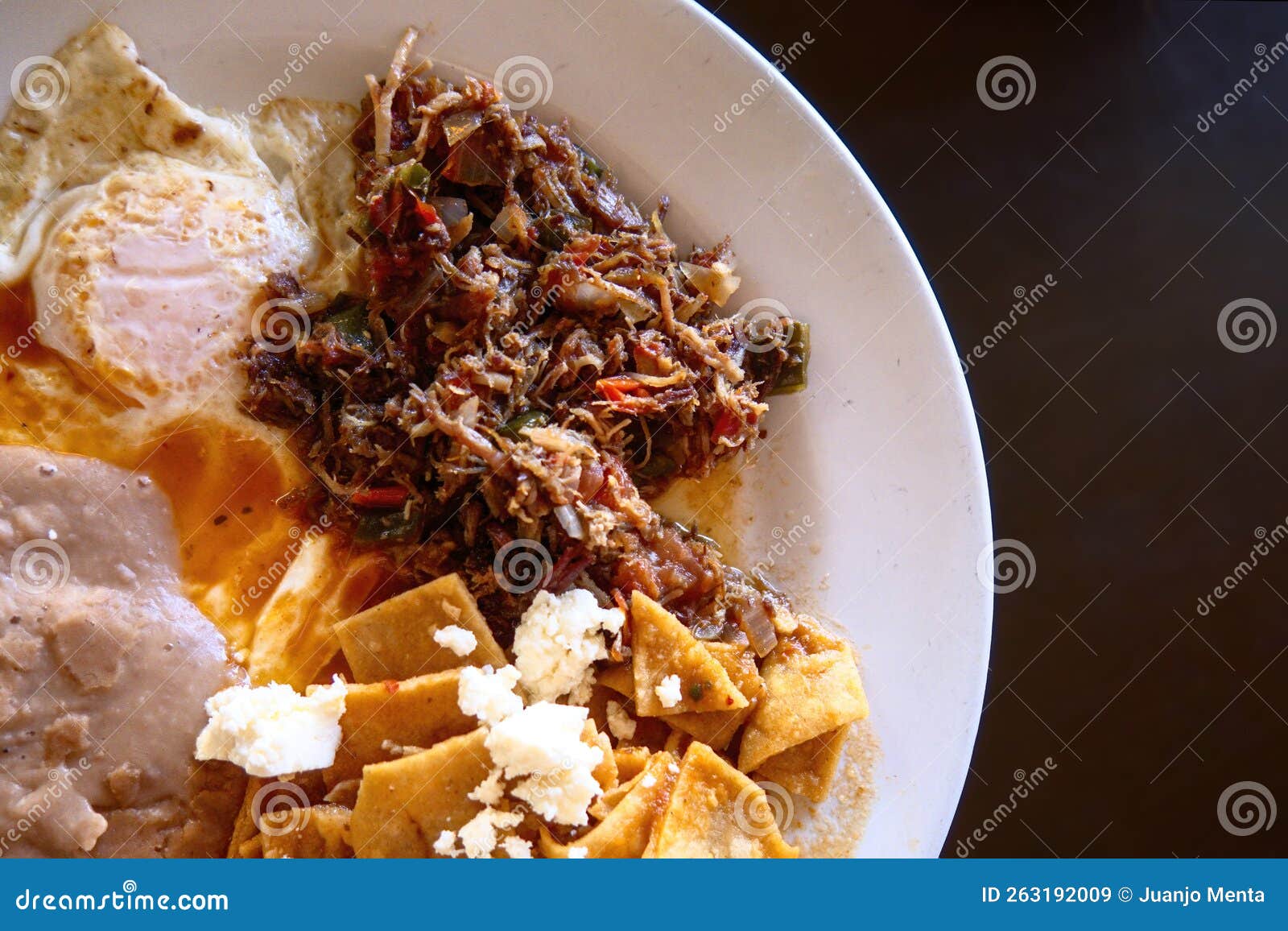 Scrambled Eggs with Machaca and Beans and Chilaquiles Stock Image ...