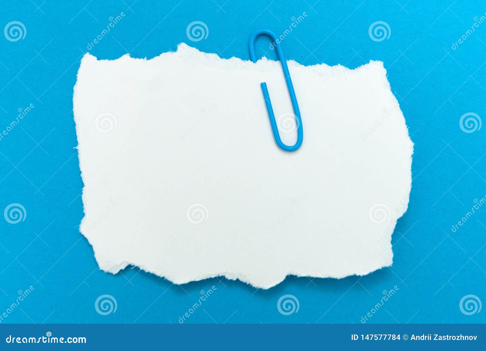 A Scrap of Reminder Paper with a Blue Paper Clip. Empty Place for Text ...