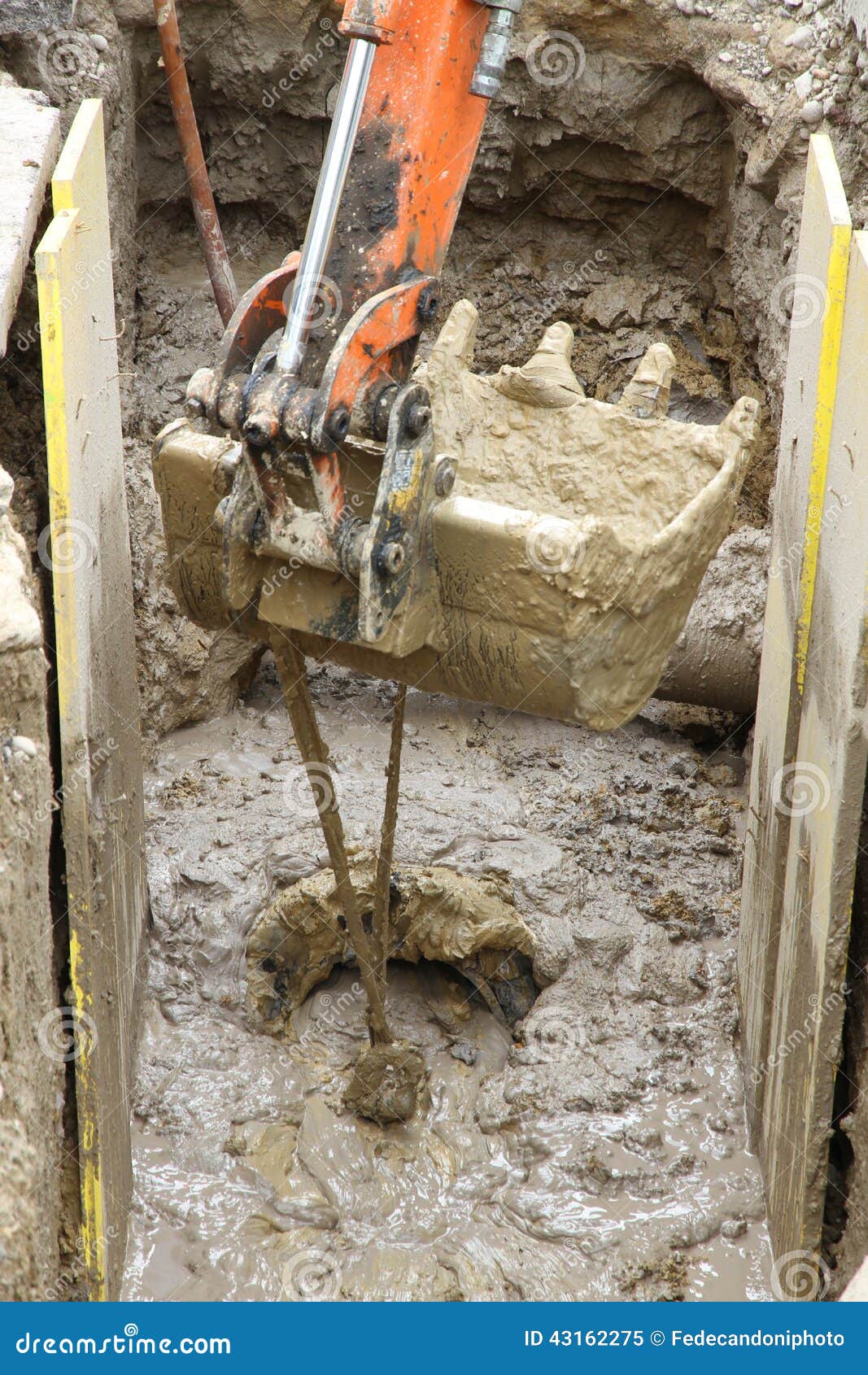 Scraper Bucket during the Work for the Laying of Underground Utilities ...