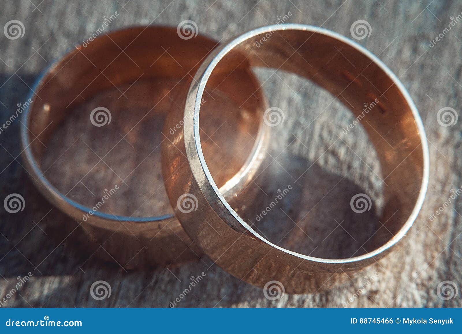 Scratched Two Wide Gold Wedding Rings on Stone Surface Stock Photo ...
