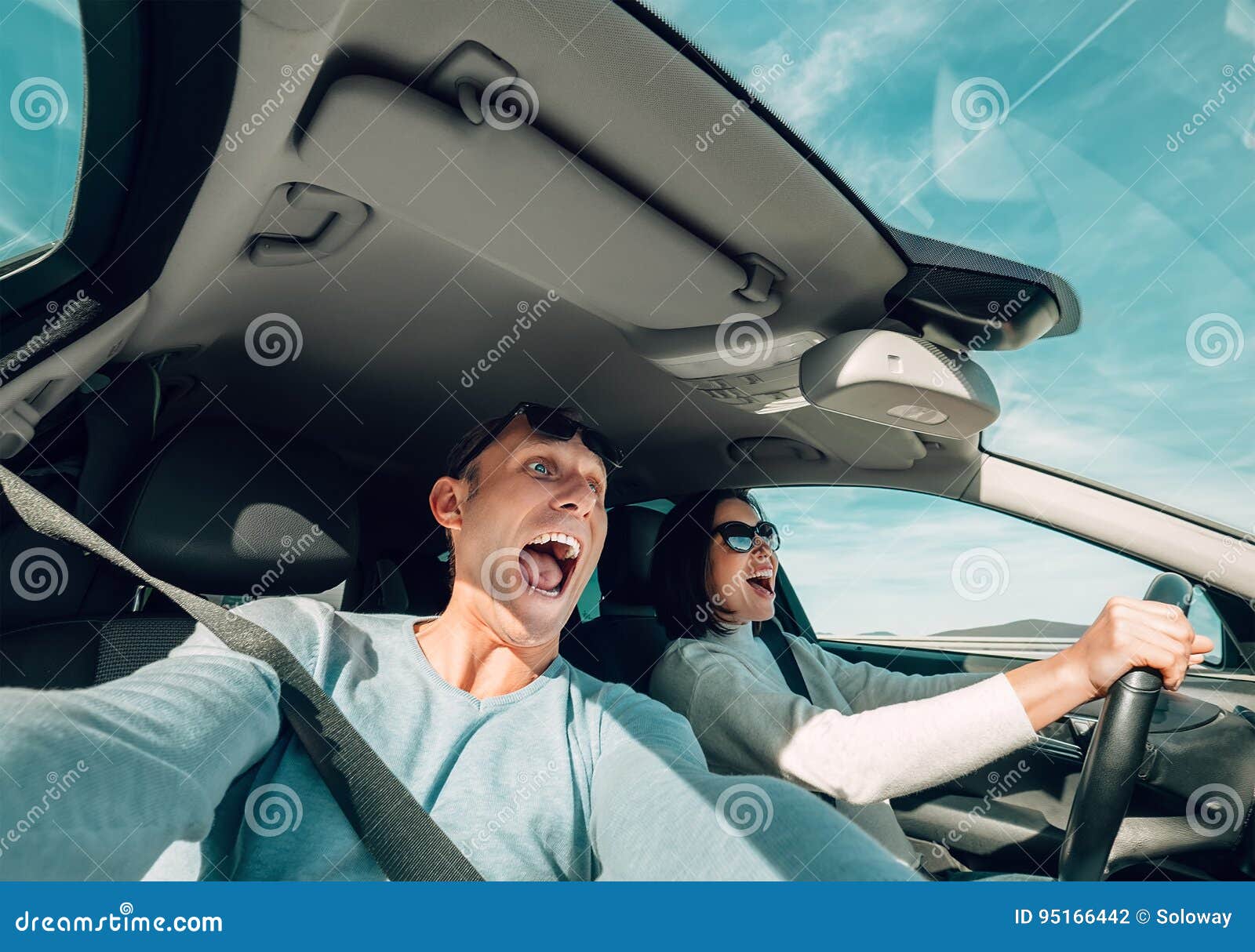 Screaming Couple Riding in Car Wide Angle View Stock Photo - Image of ...