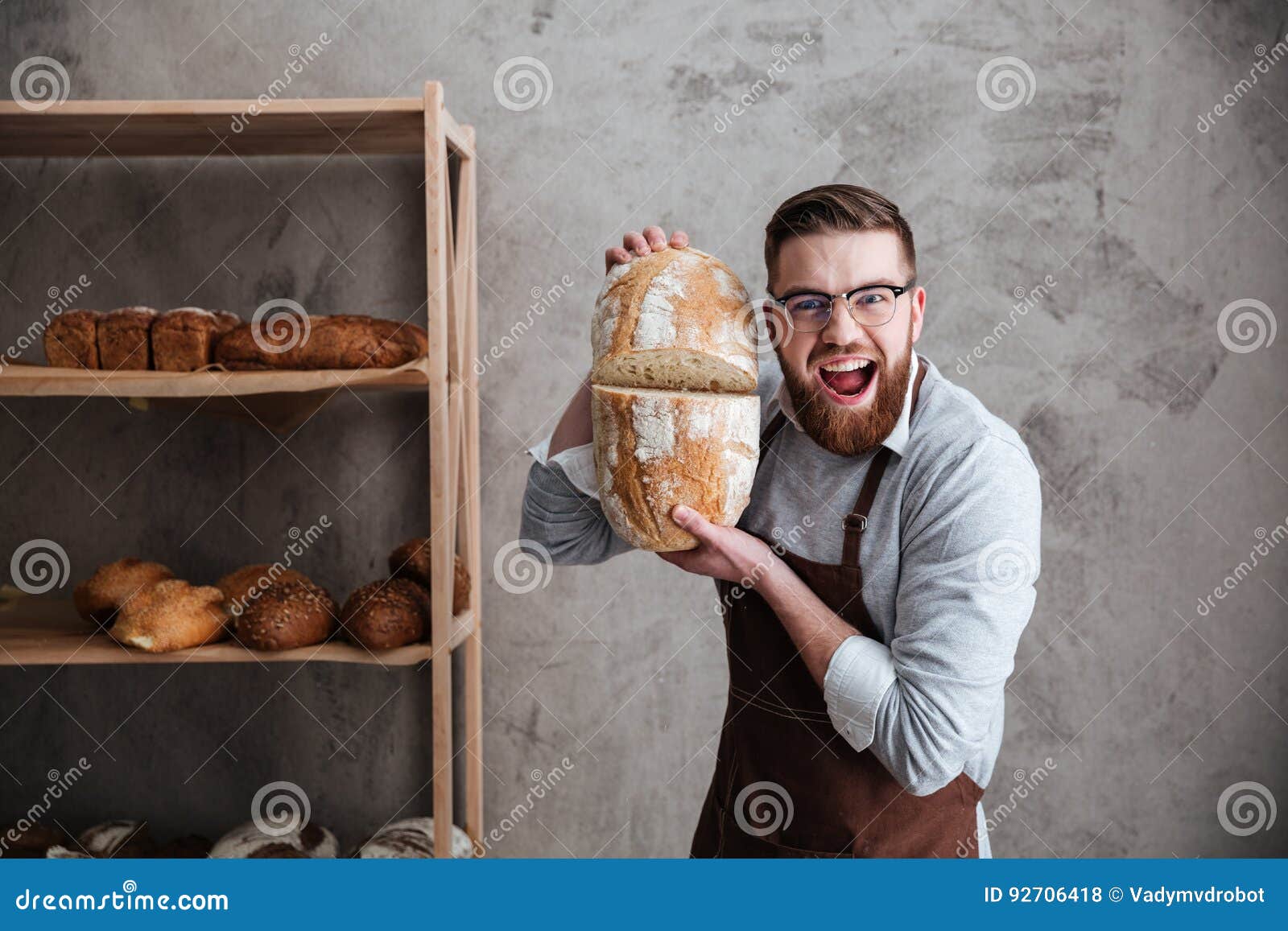 Screaming Young Man Baker Standing at Bakery Holding Bread Stock Photo ...