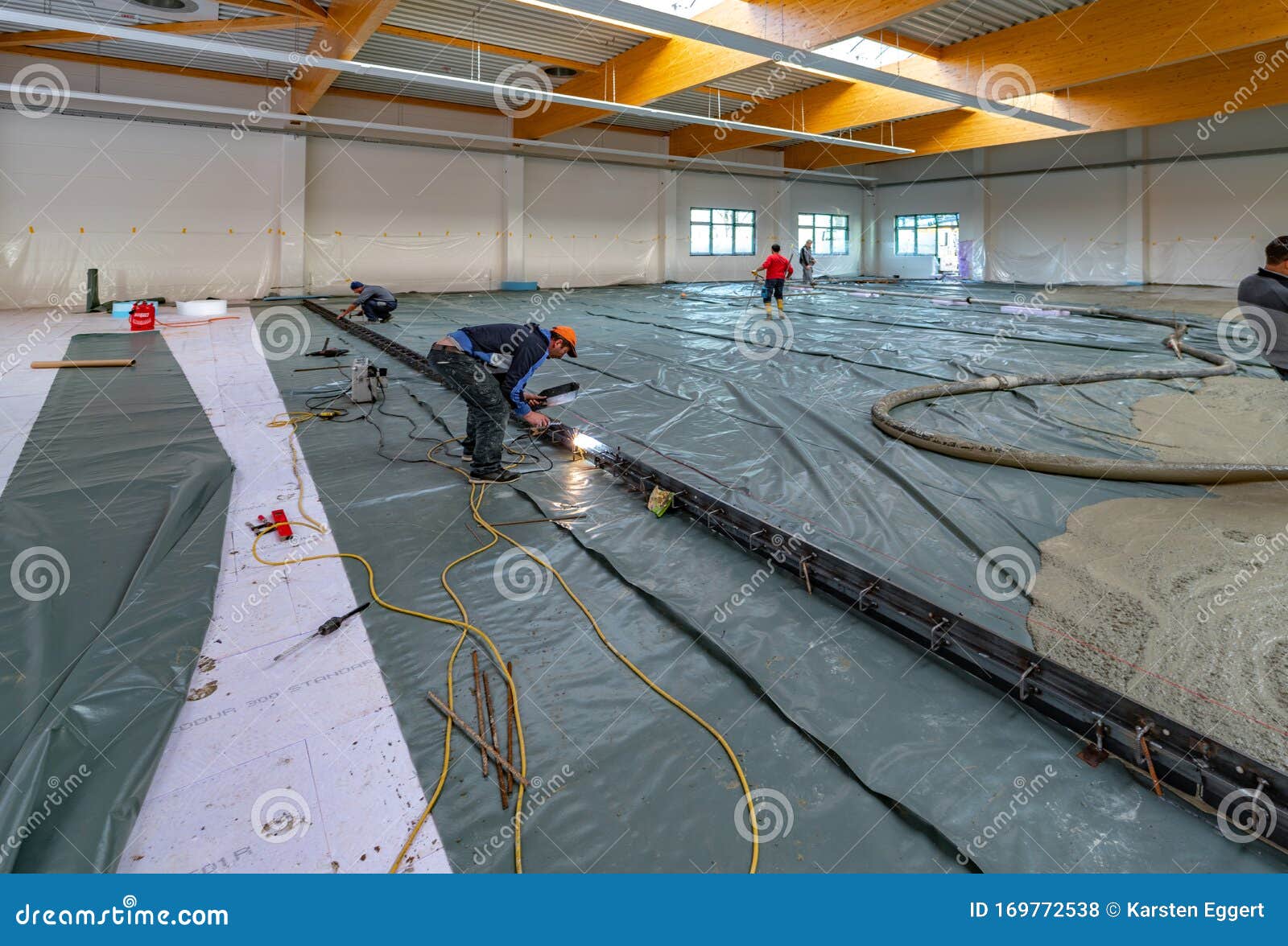 Screed is Poured on a Construction Site Inside a Large Factory Building ...