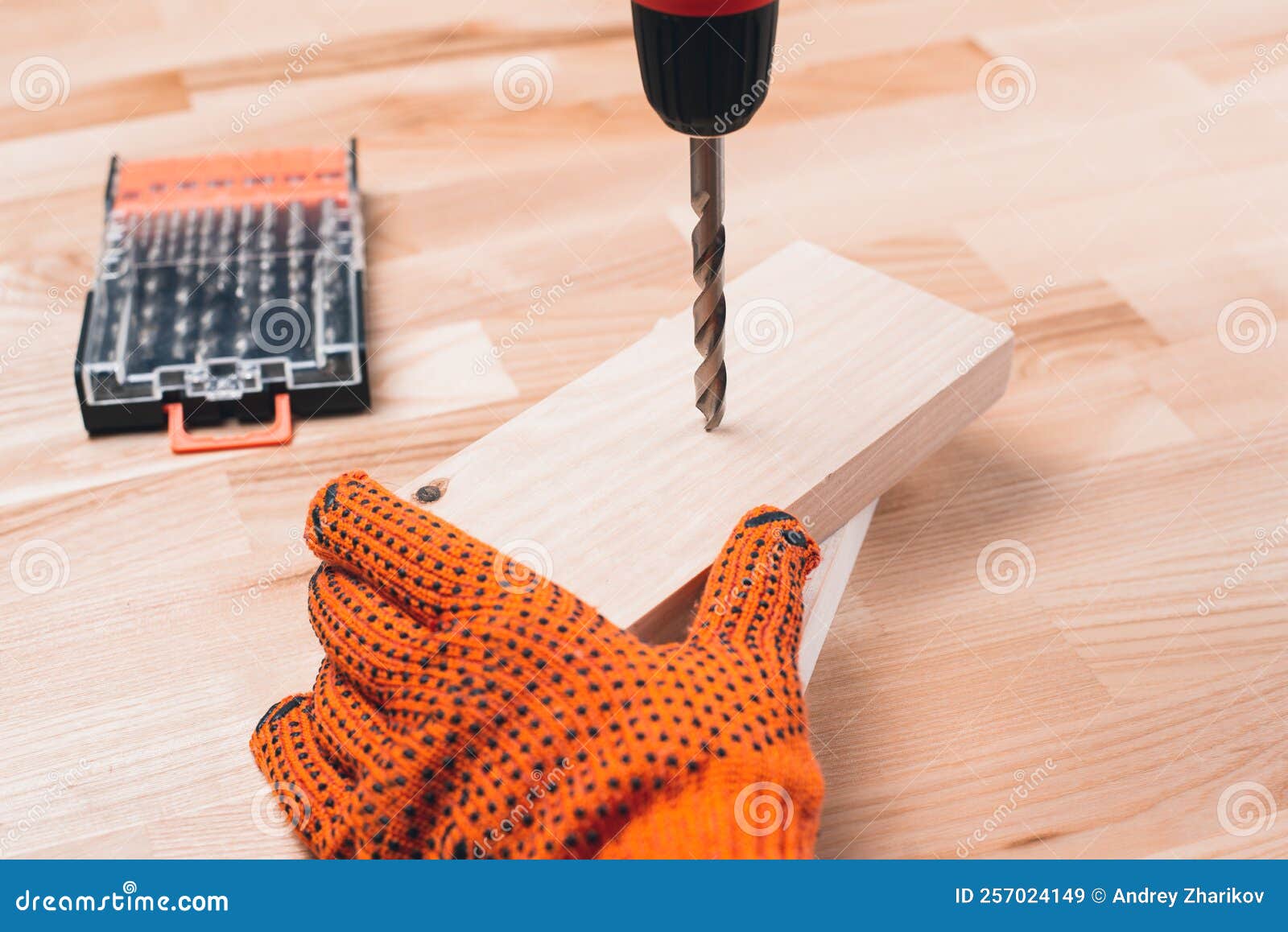 Screwdriver Drill in Hand. Gloved Hands. the Master Drills Wooden ...
