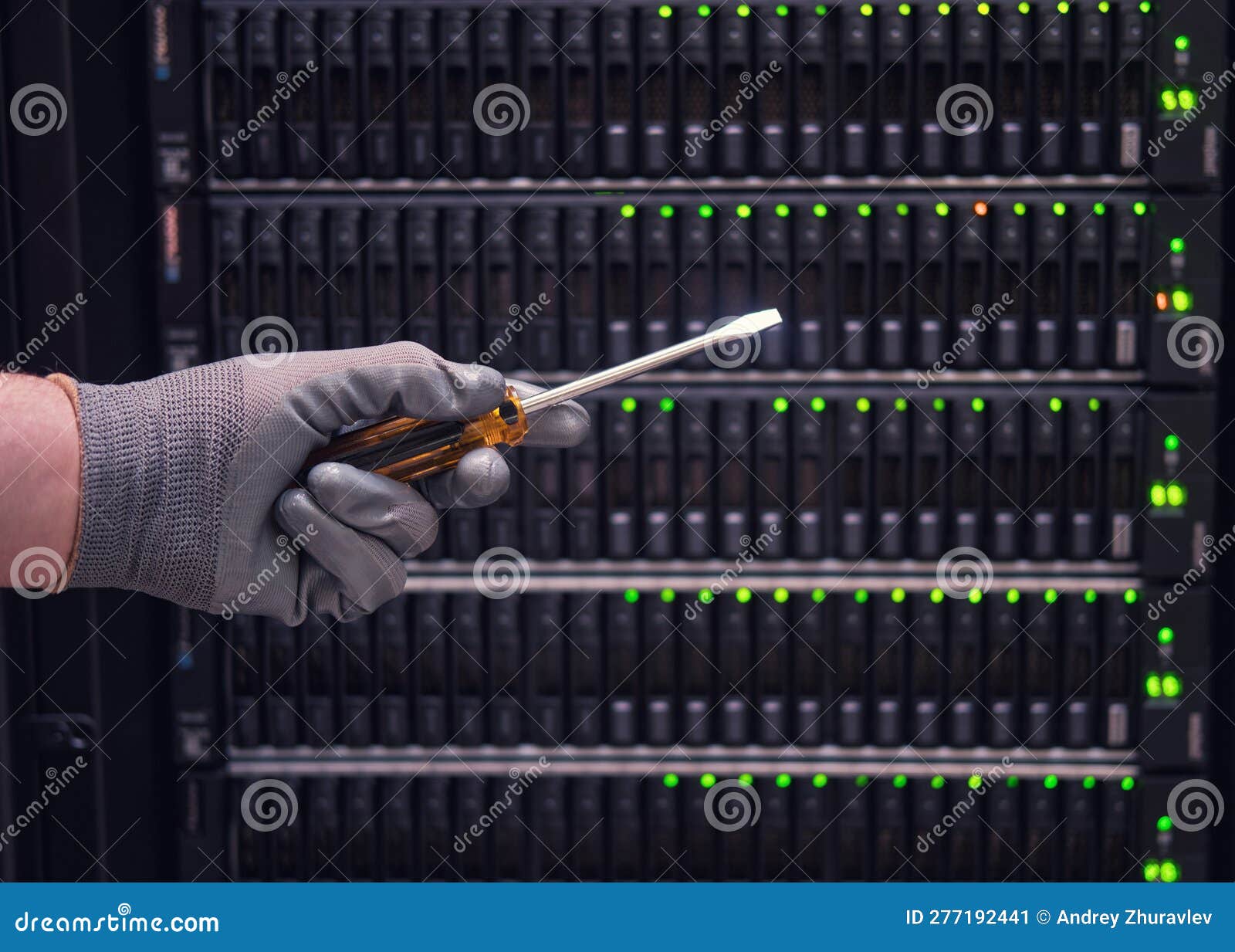 Screwdriver in the Hands of a Man at the Server for Data Storage, Close ...