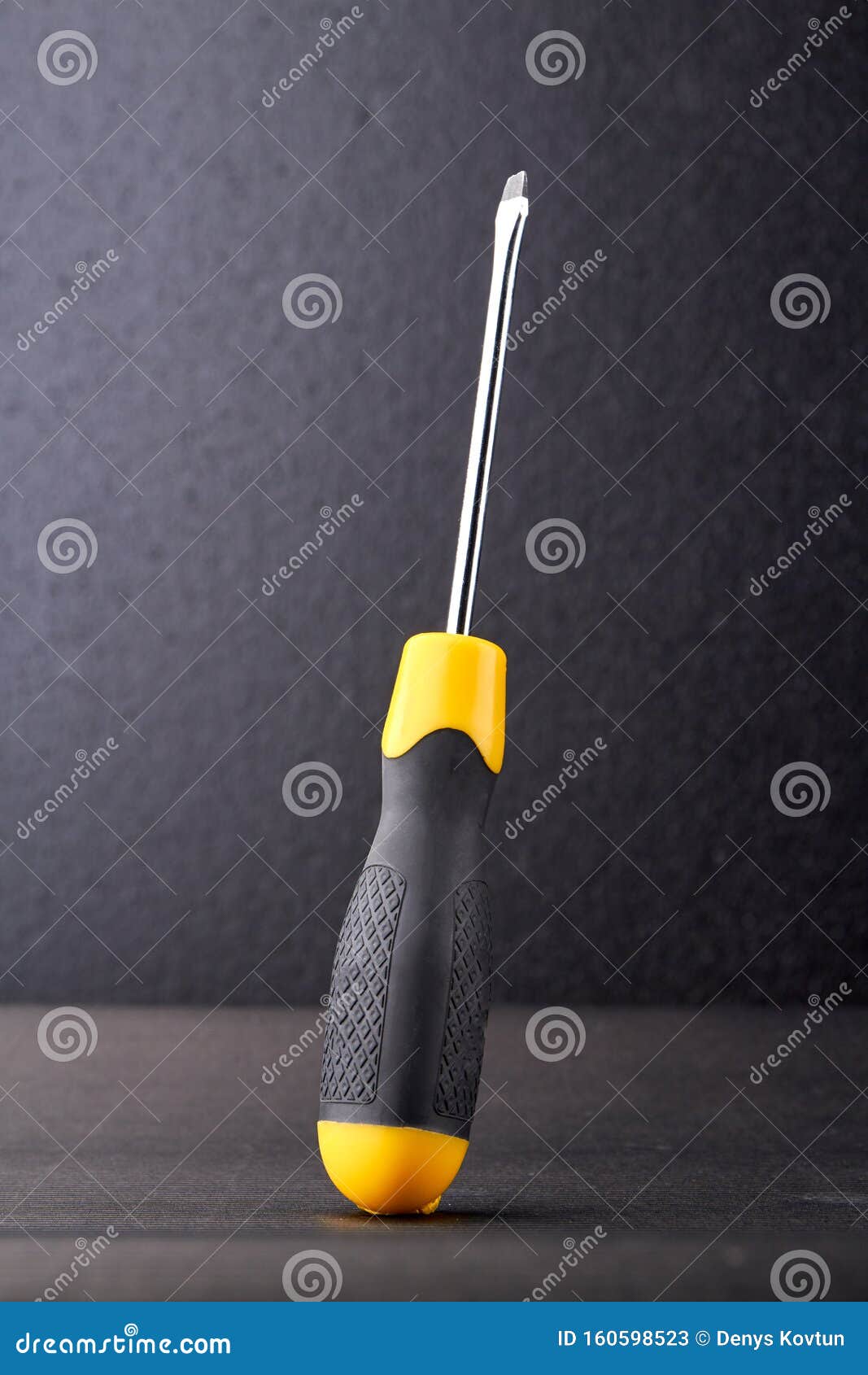 Screwdriver with Rubber Handle on Dark Background. Stock Image - Image ...