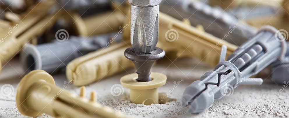 Screwdriver and Dowel in a Concrete Wall Background Stock Image - Image ...
