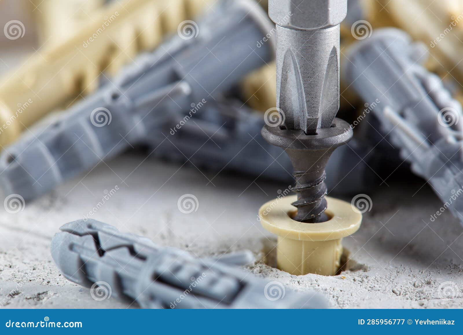Screwdriver and Dowel in a Concrete Wall Background Stock Image - Image ...