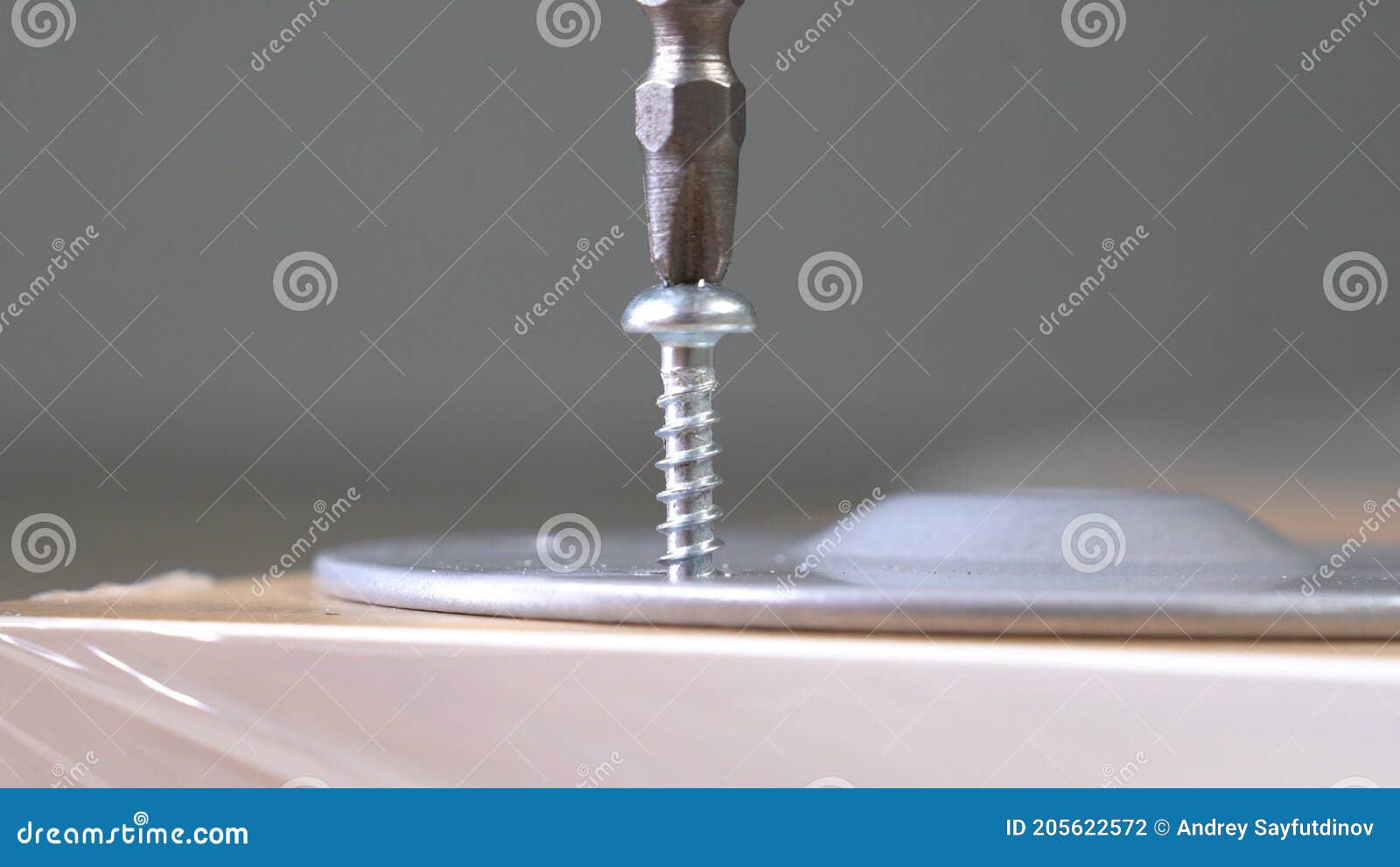 Screwdriver Screwing the Screws into the Table Leg Support. Stock Photo ...