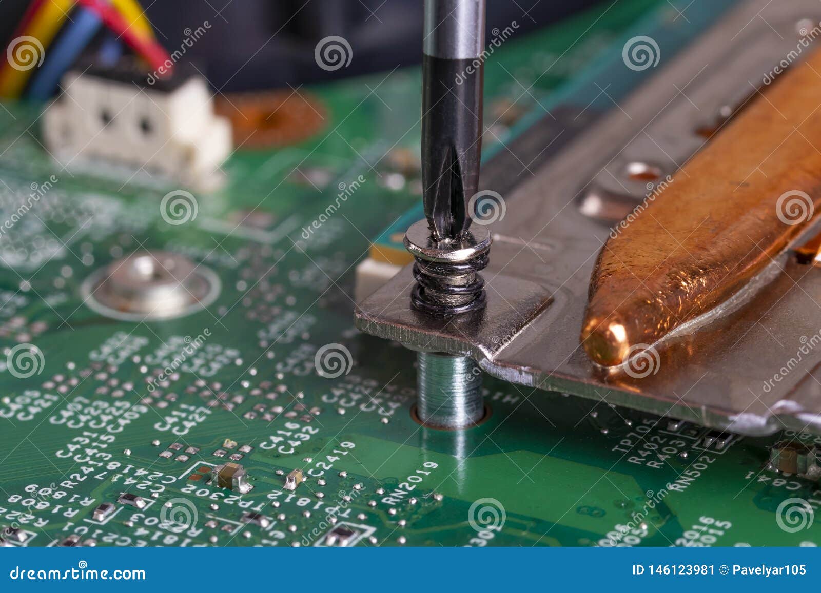 A Screwdriver Unscrews the Mounting Bolt of the Computer Board Stock ...