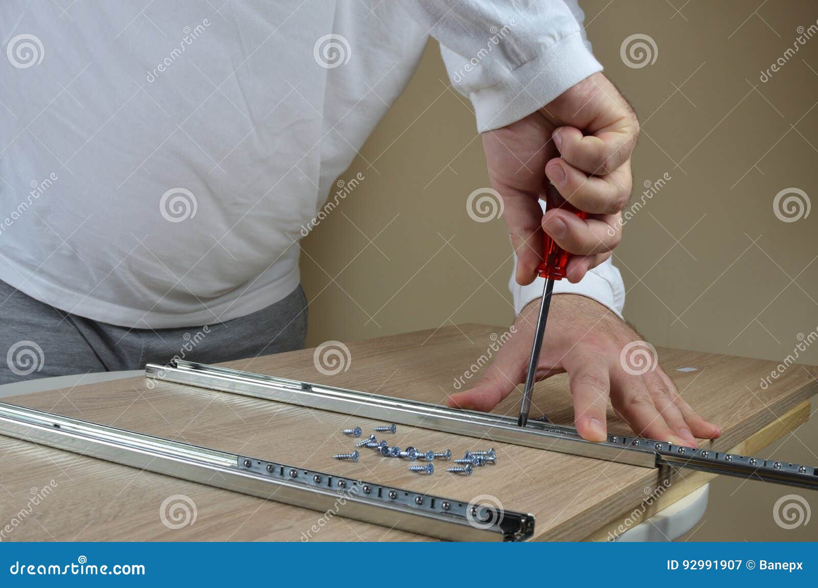 Screwing Rails for Drawers stock image. Image of screwdriver - 92991907