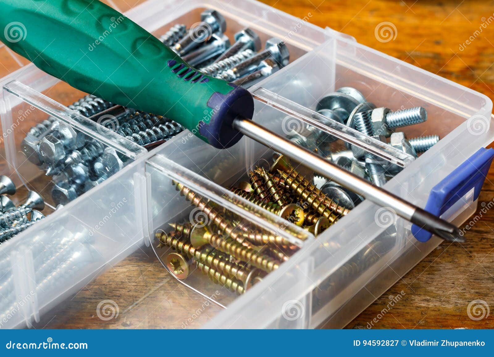 Screws and Bolts in the Storage Box with Screwdriver on the Workbench ...